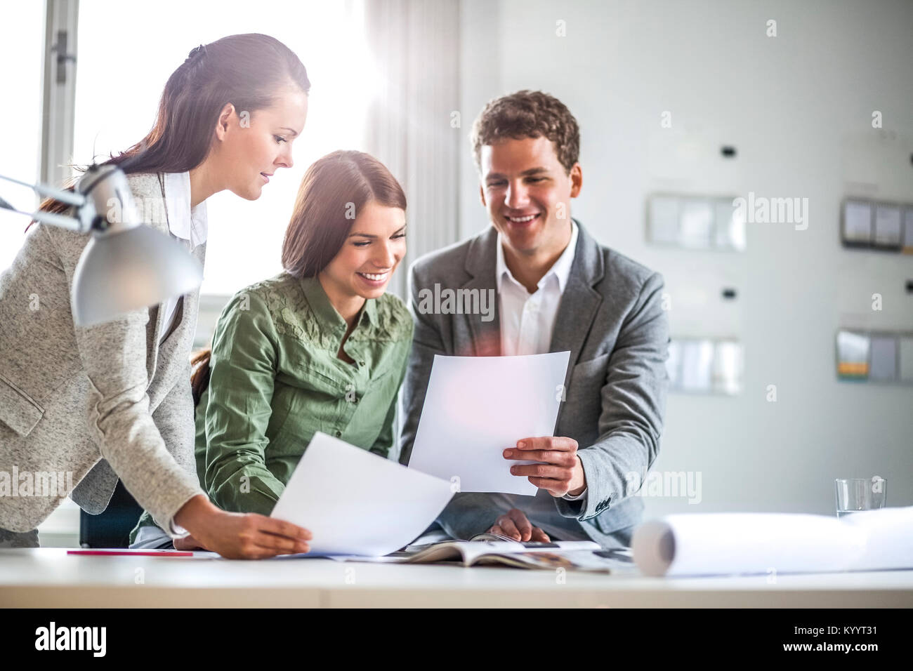 Business people reviewing documents in office Stock Photo - Alamy