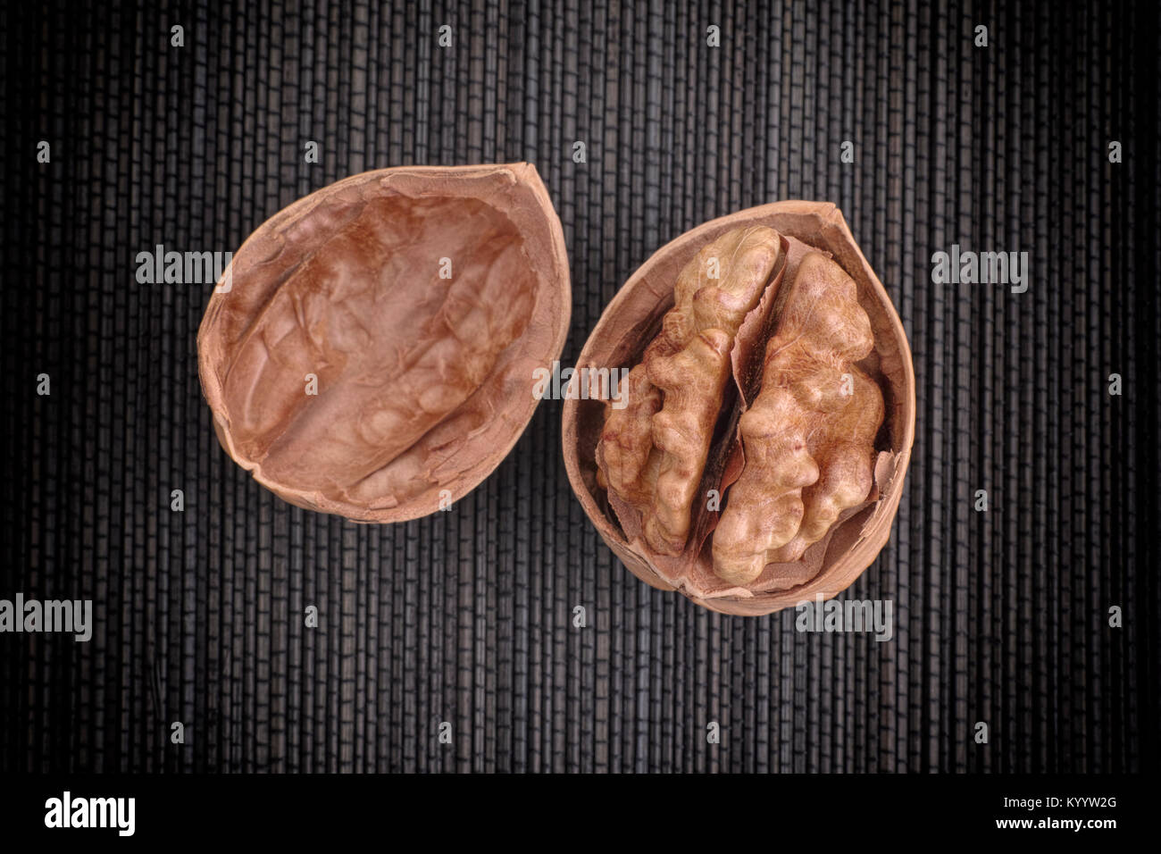 Cracked walnut on a black Background. Close up Stock Photo - Alamy