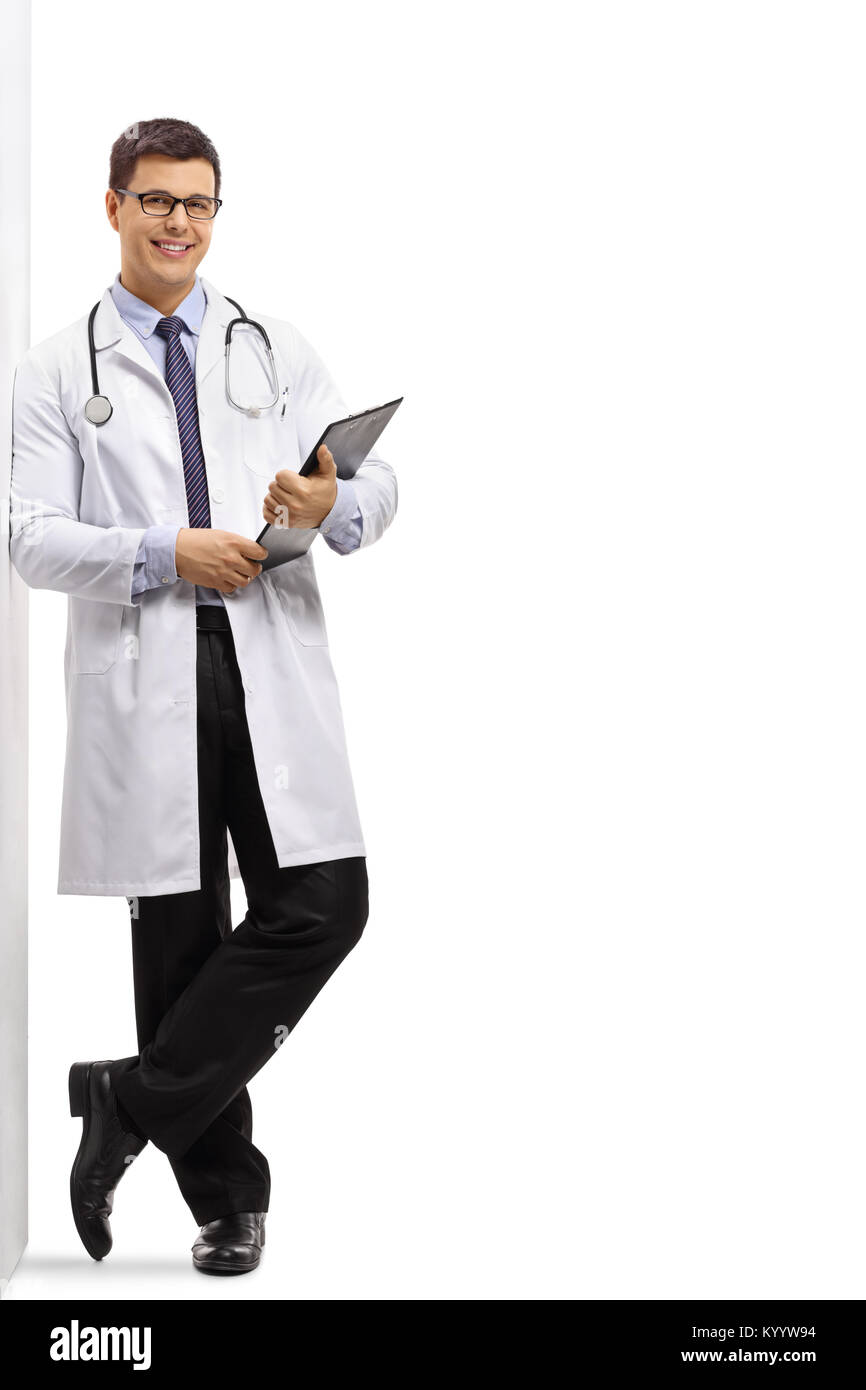 Full length portrait of a doctor with a clipboard leaning against a ...