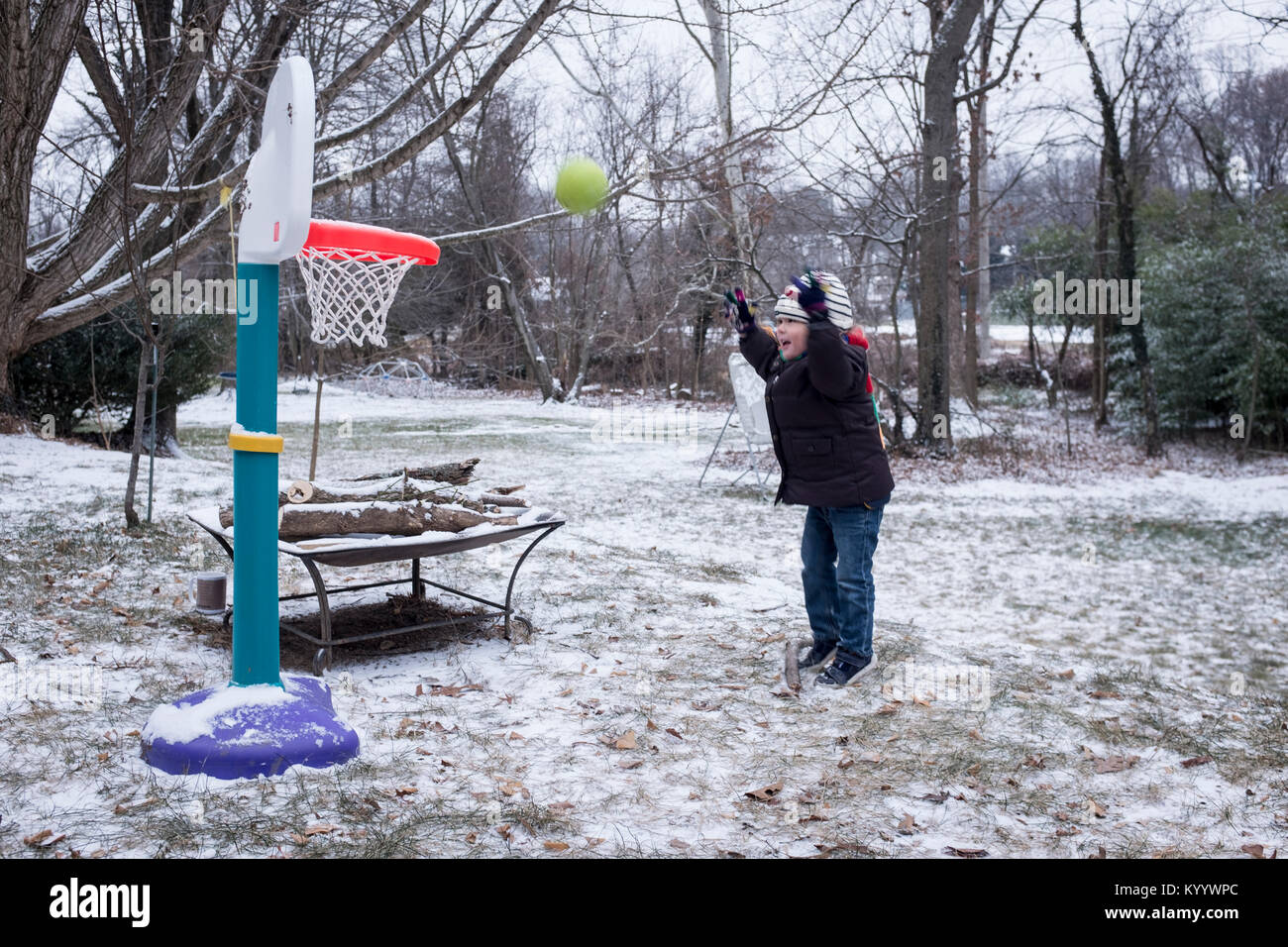 Little boy plays basketball in the snow in McLean, Virginia Stock Photo ...