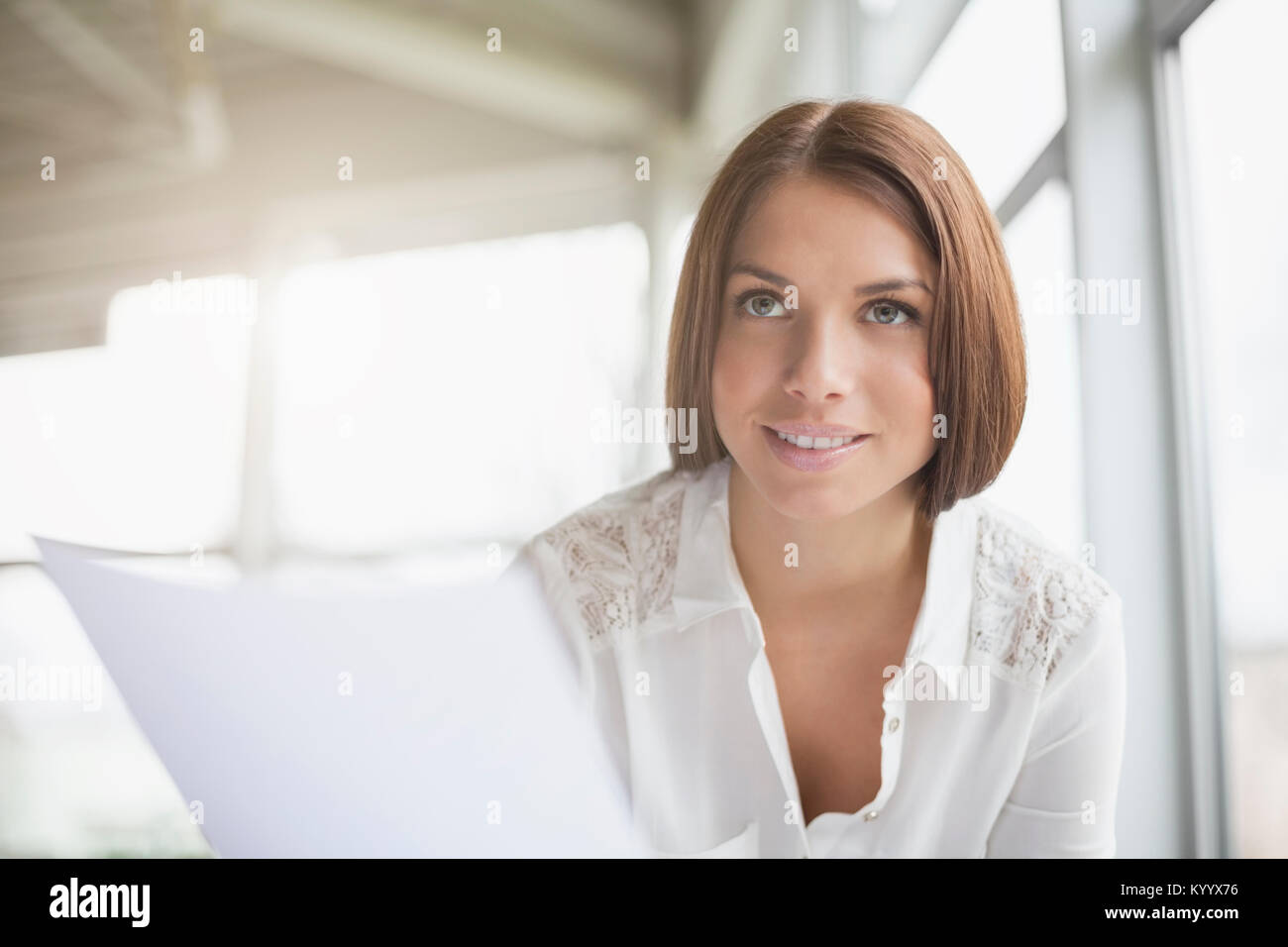 Young businesswoman giving document in office Stock Photo - Alamy