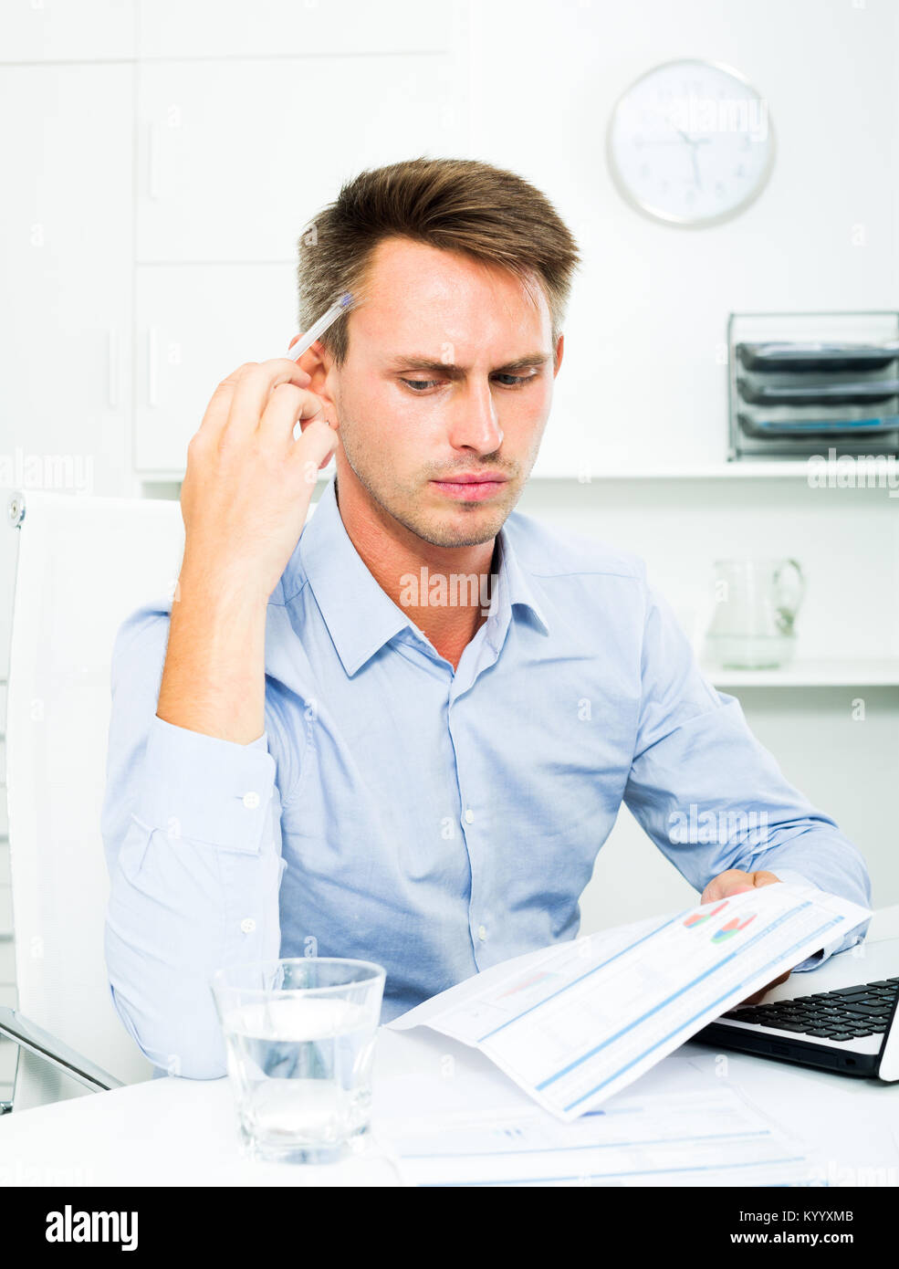 Upset man sitting at working desk with laptop and having work troubles ...