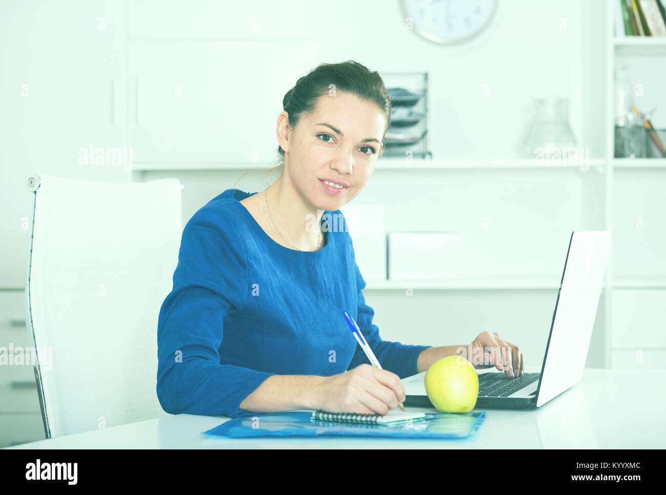 Smiling woman worker working effectively on project in office Stock ...