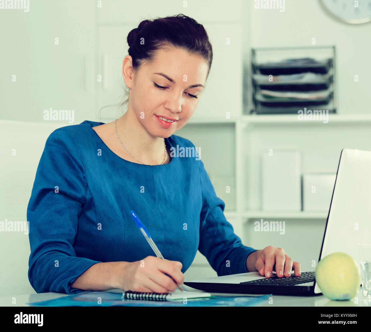 Smiling woman worker working effectively on project in office Stock ...