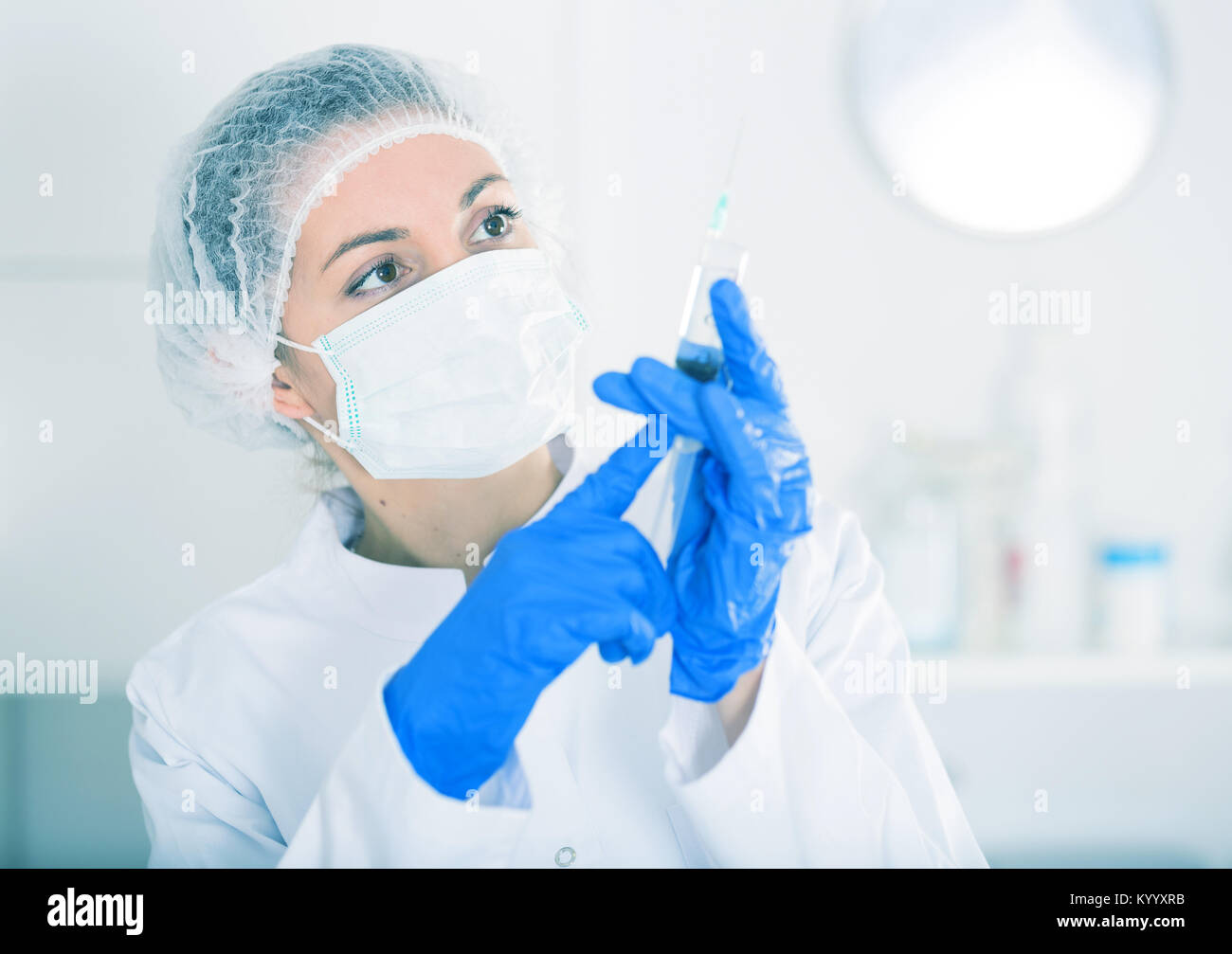 Young female nurse ready to make injection in hospital Stock Photo - Alamy