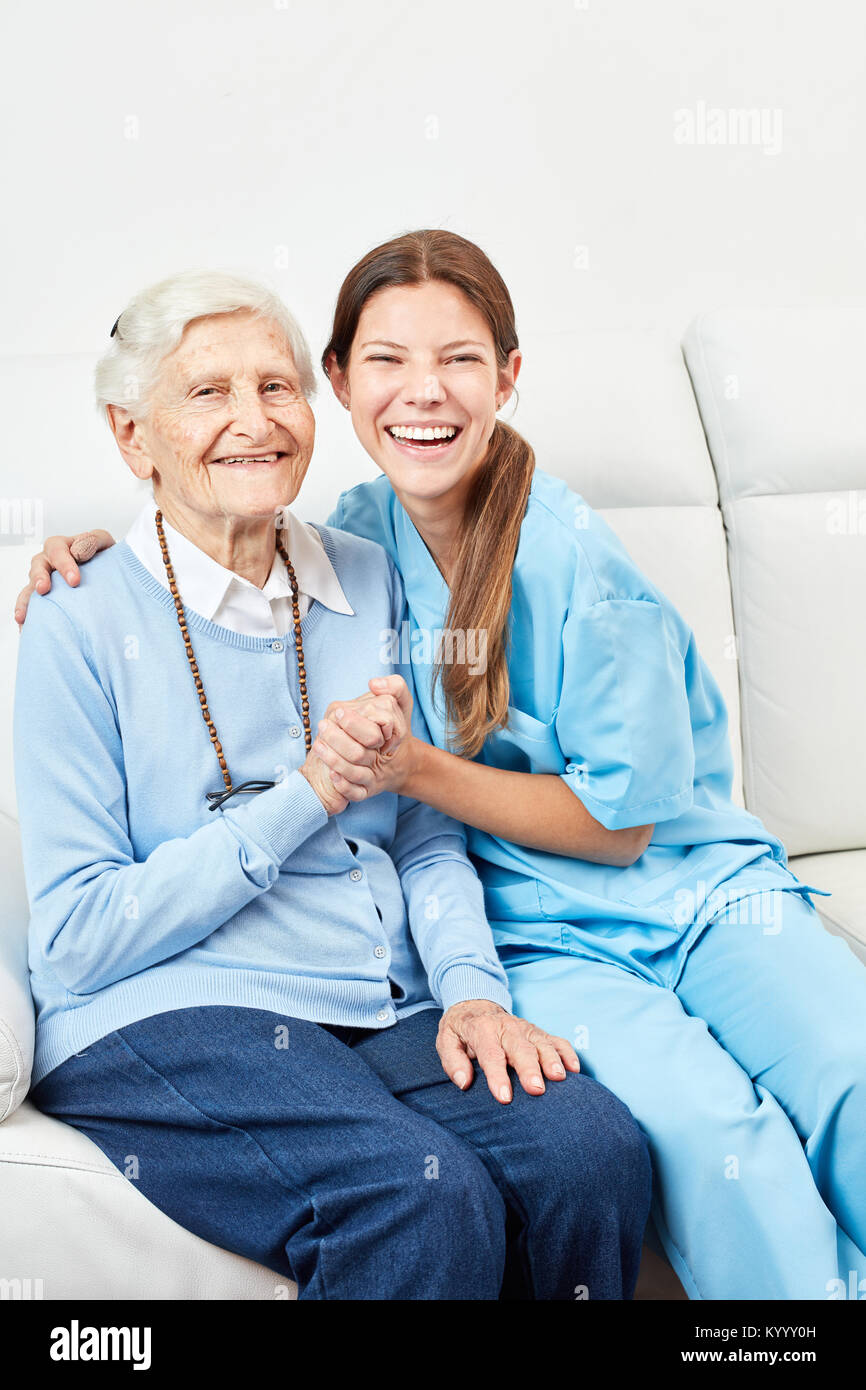 Smiling nurse on home care makes home visit to happy senior citizen ...