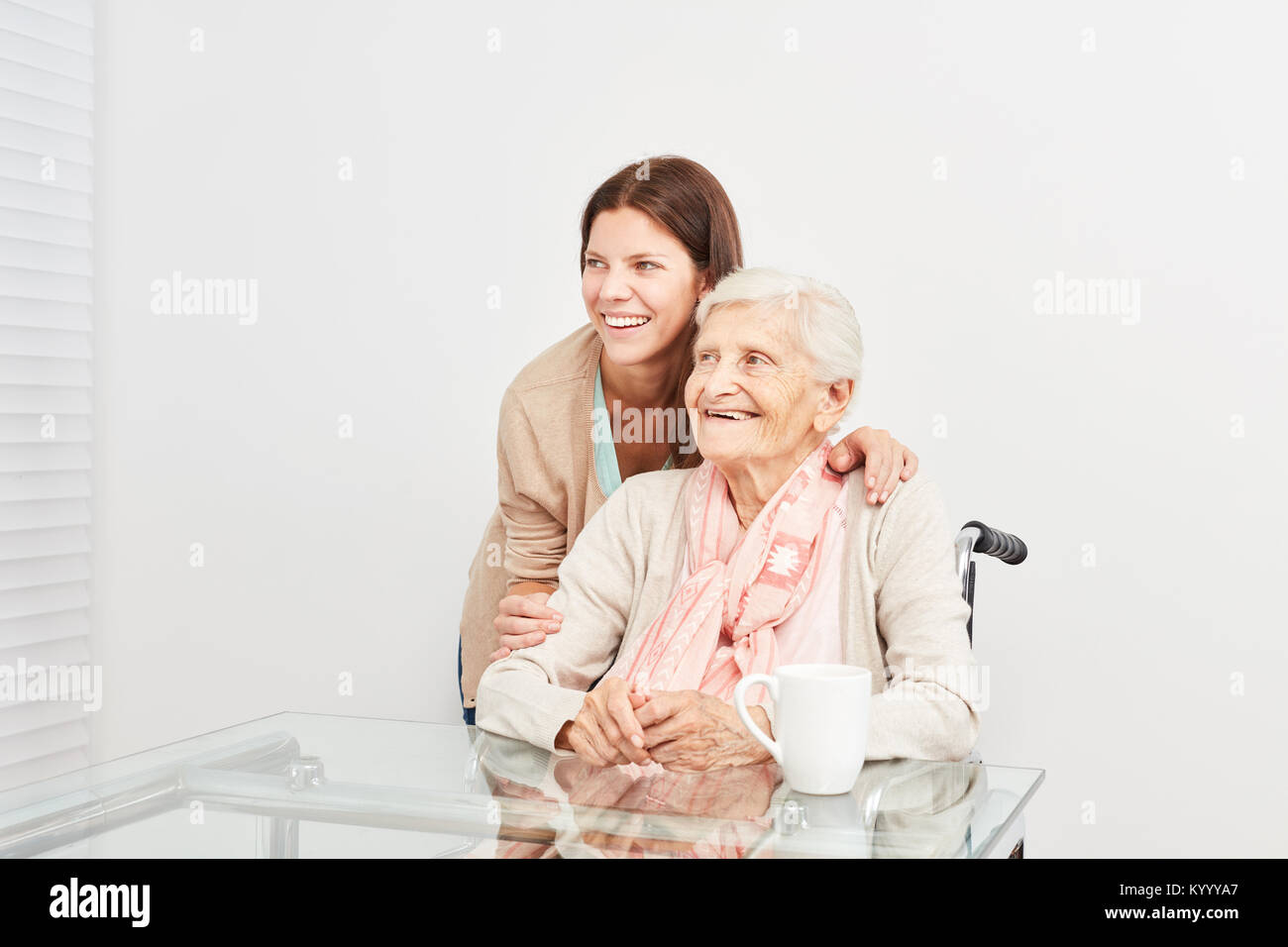 Young woman as a granddaughter or nursing assistant makes home visit ...