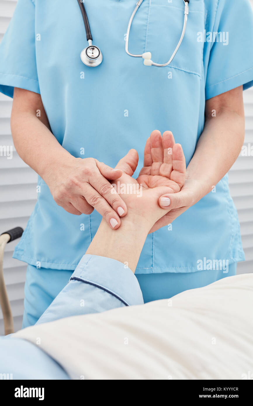 Nurse checks the pulse of a patient in the hospital Stock Photo - Alamy