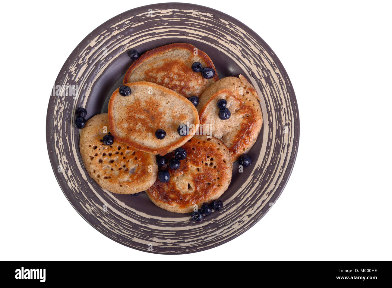 Wholegrain flour fritters with bilberry on a plate isolated on white ...
