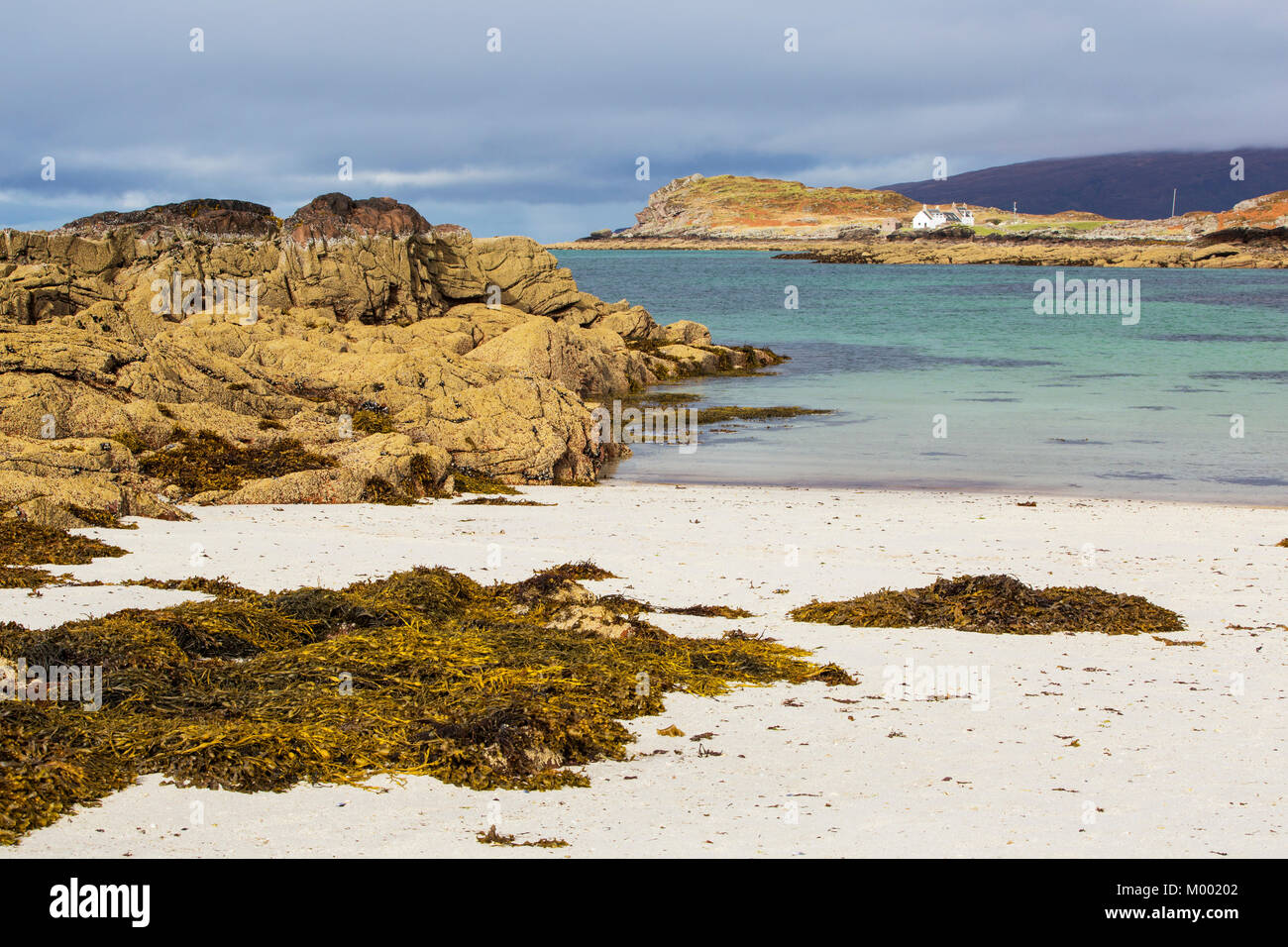 A corla sand beach and Barnacles growing on rocks at Coillegillie near ...