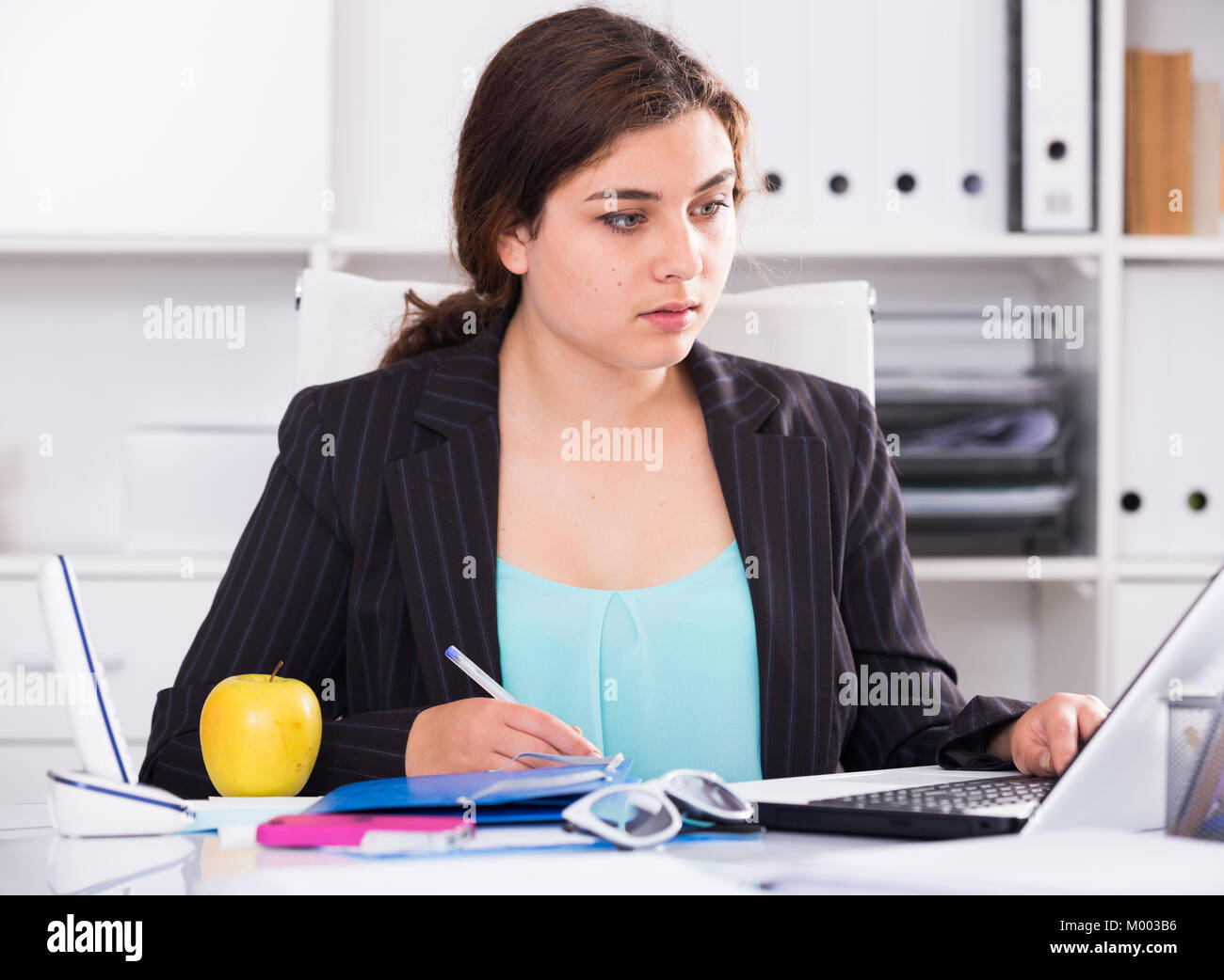 Female trainee 20-25 years old is having productive day at work in ...