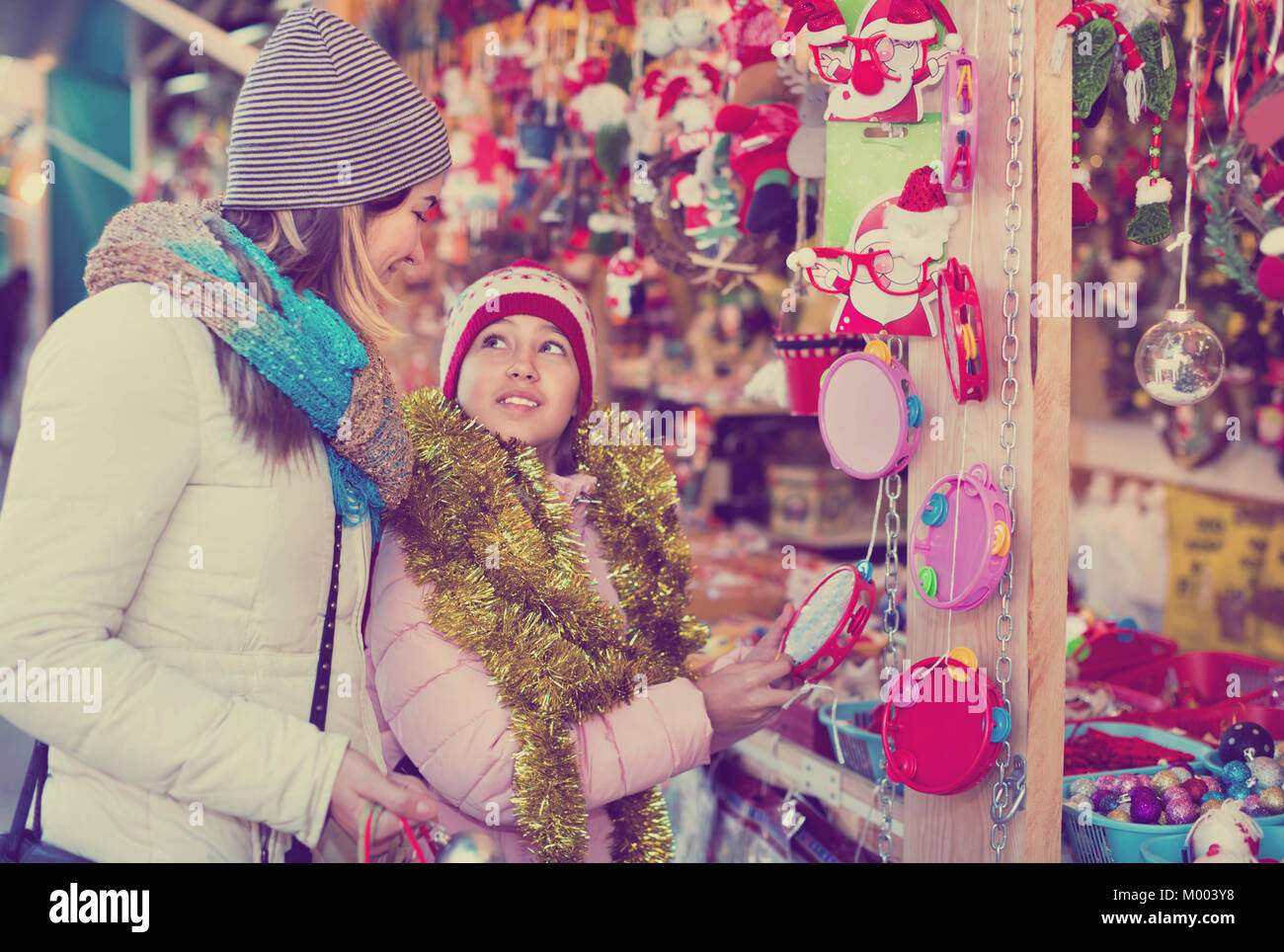 Female customers staring at counter of Christmas market. Focus on woman ...