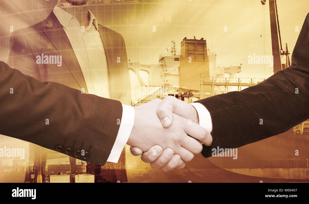 Business handshake on background of construction crane in rays of light ...