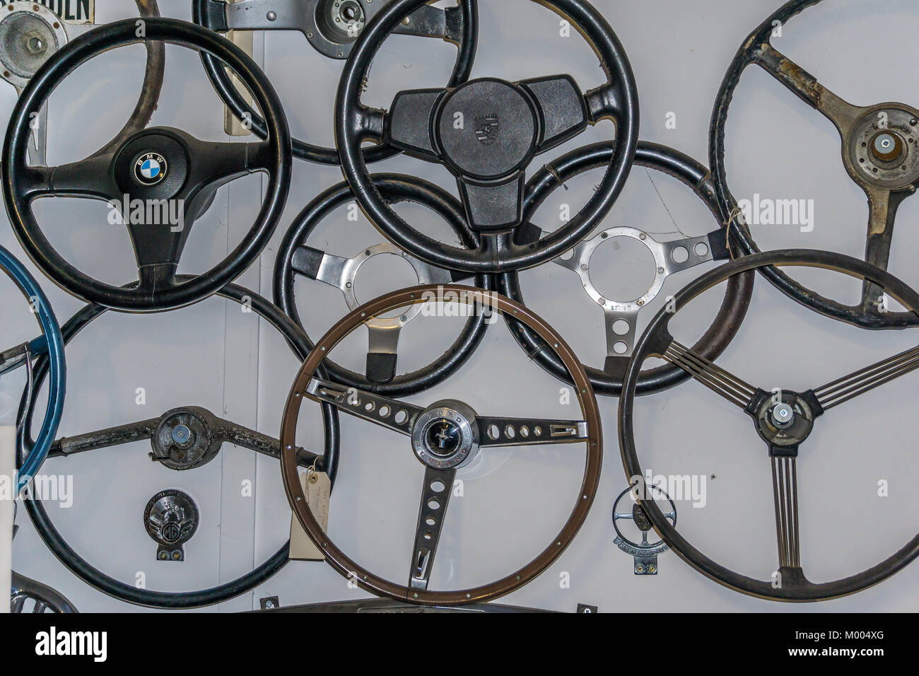 Steering wheels from vintage cars wall mounted to form a display at the ...
