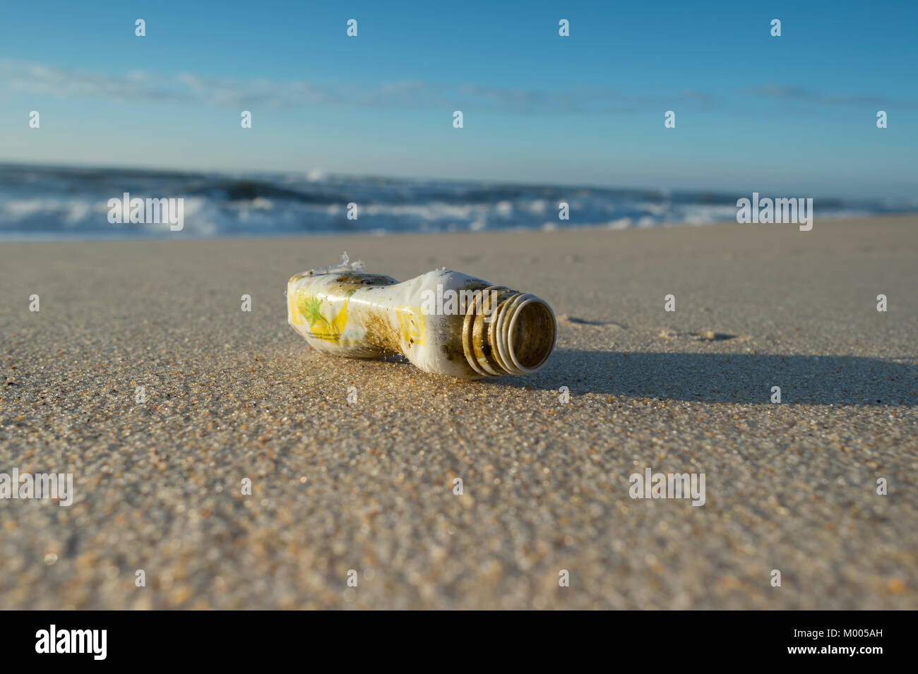 plastic bottle washed up on a deserted beach, Ocean pollution with non ...