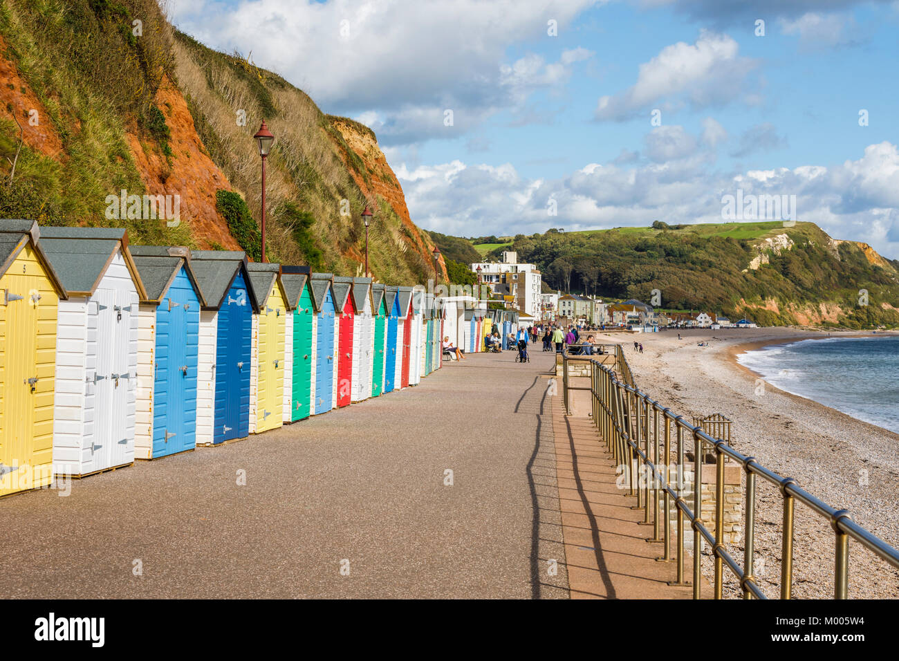 Colourful beach huts under the cliffs along the seafront promenade at ...