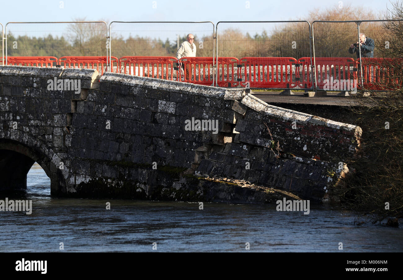 People view the damage to the old Wool bridge over the River Frome in ...