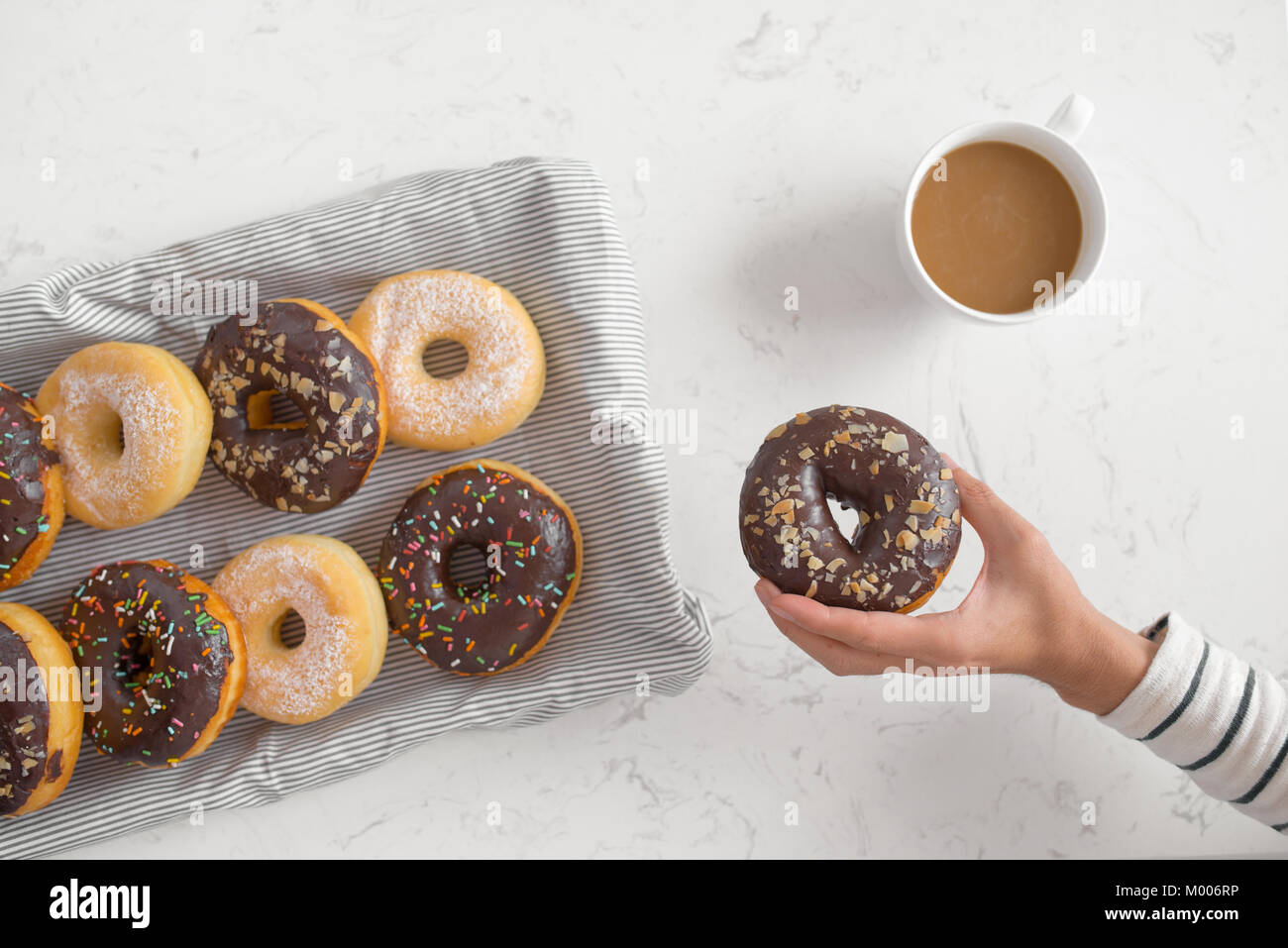 Donuts in hand. Fresh homemade doughnuts with icing Stock Photo - Alamy