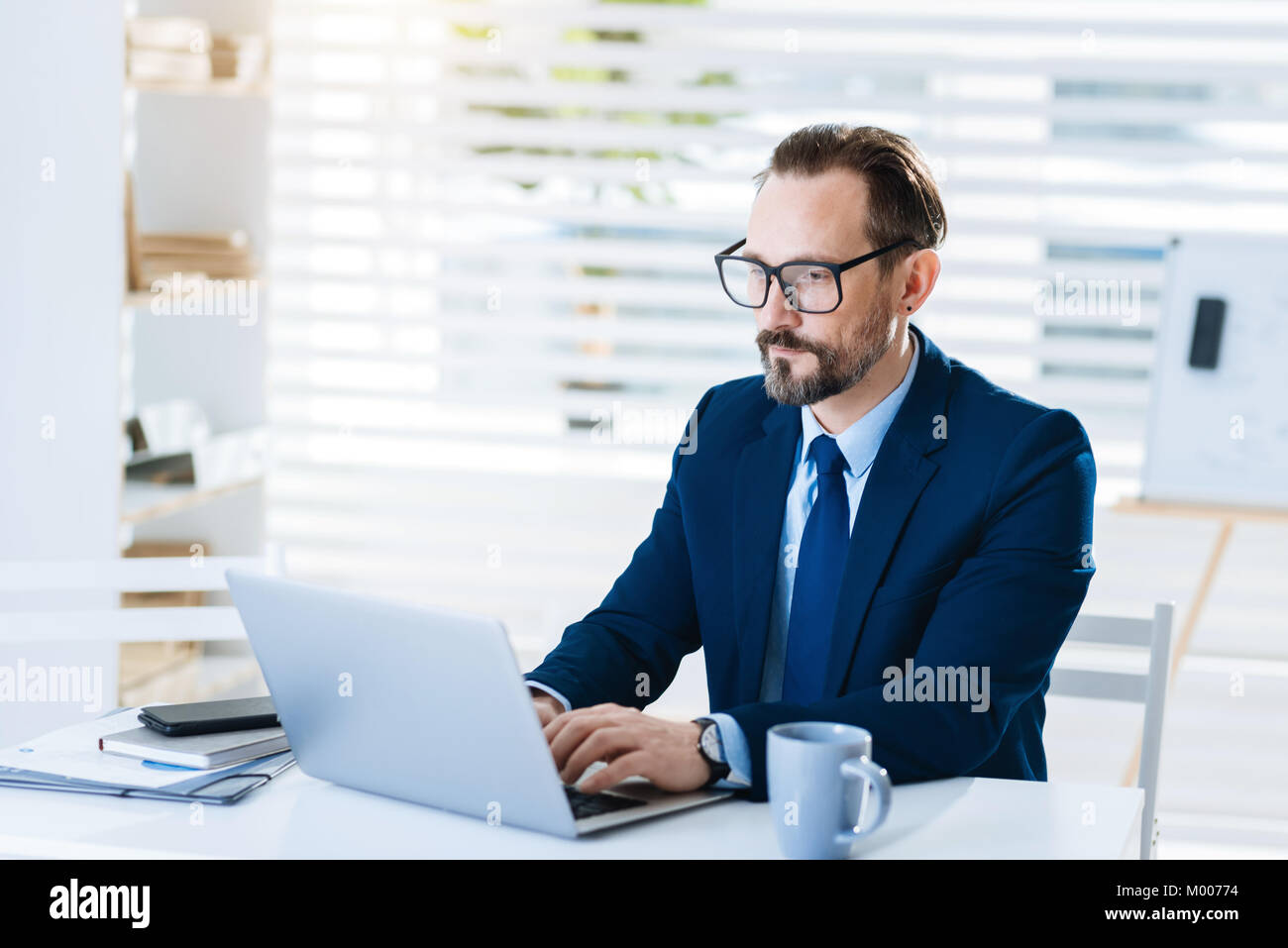 Smart confident man typing email Stock Photo - Alamy