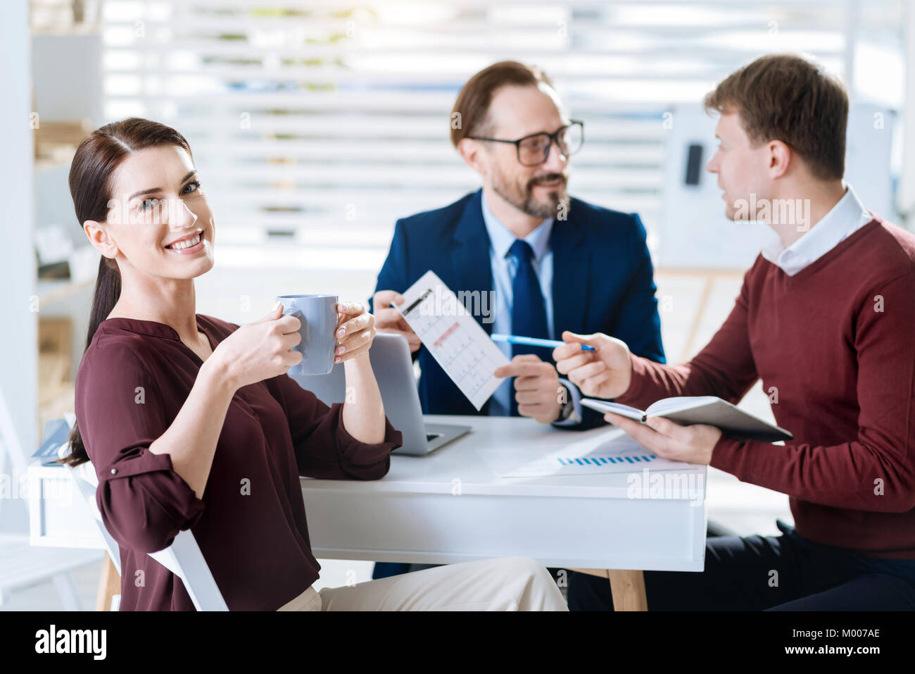 Busy three colleagues practicing team work Stock Photo - Alamy