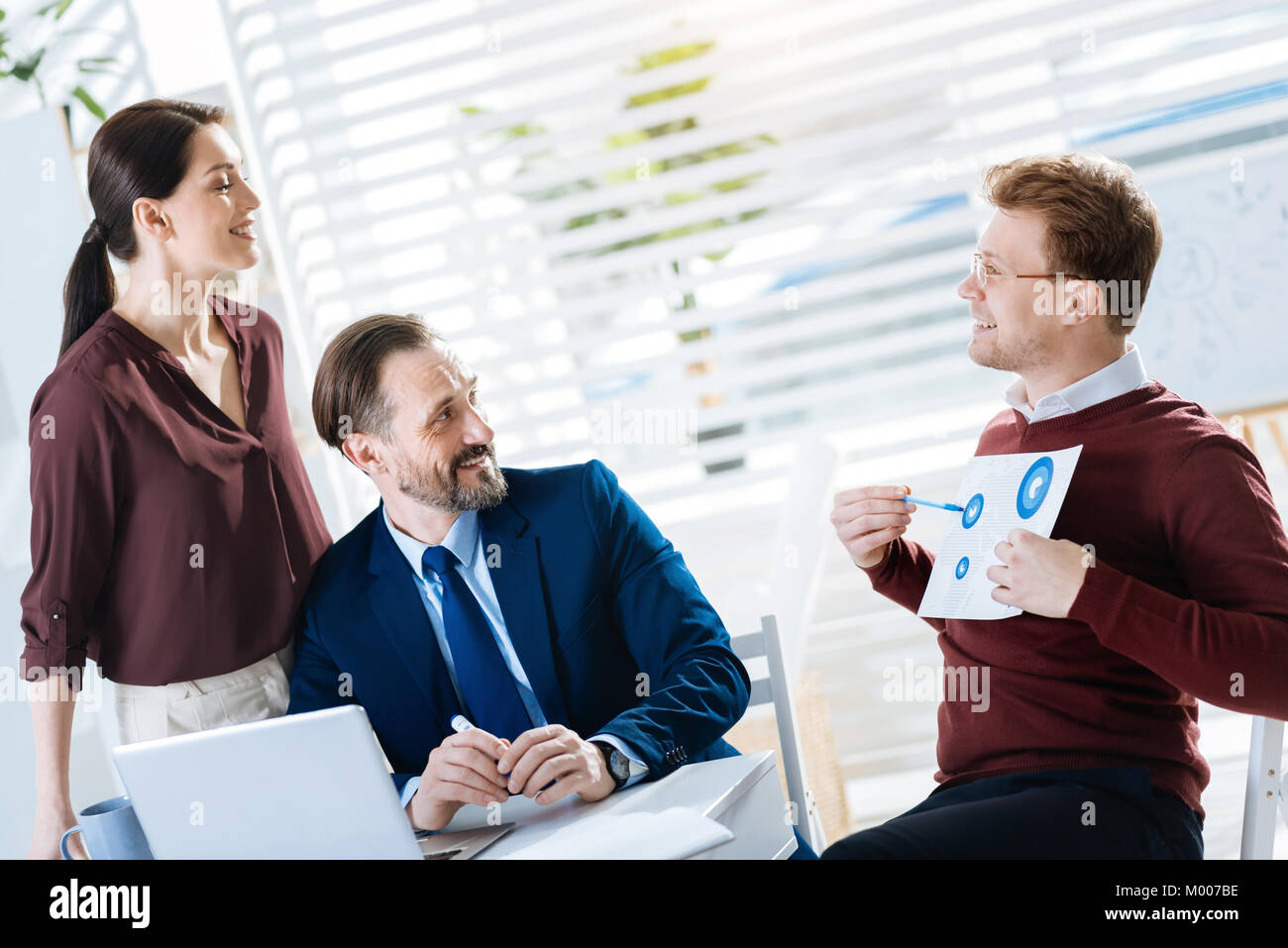 Happy three colleagues sharing ideas Stock Photo - Alamy