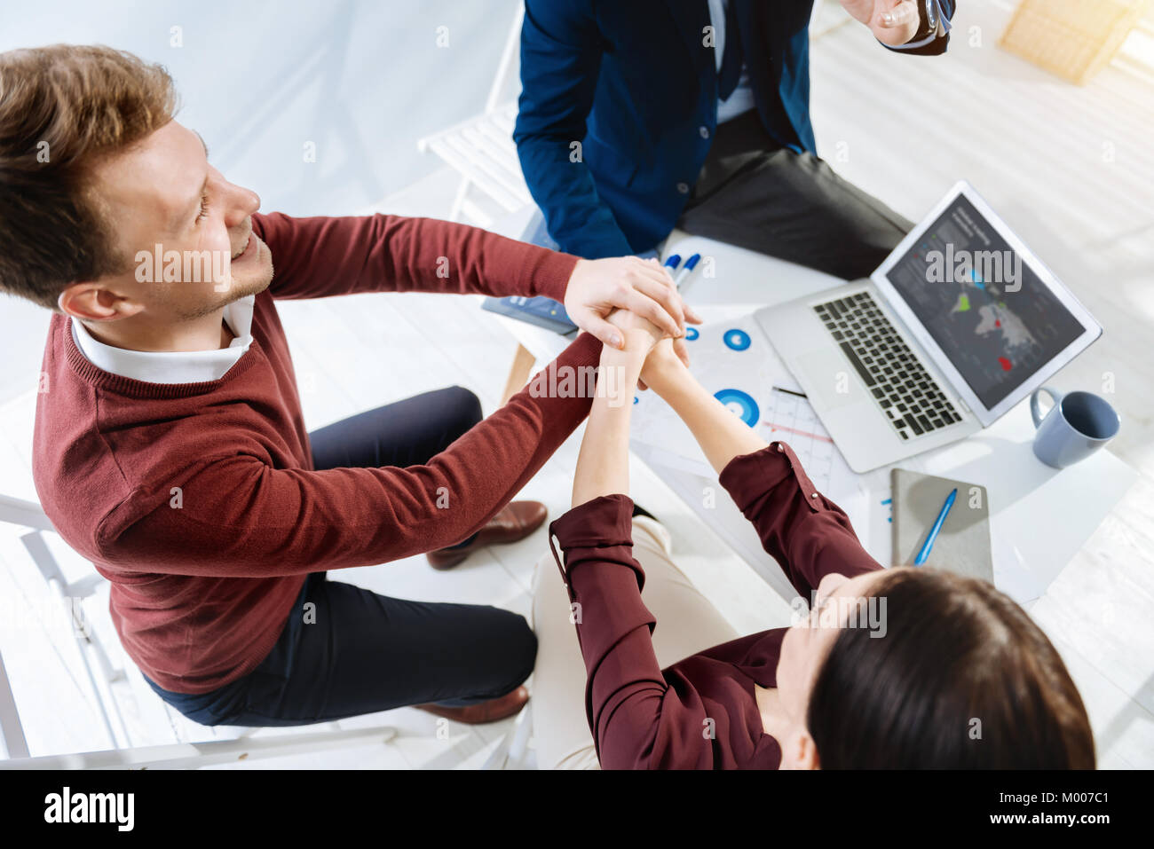 Vigorous three colleagues deciding to act Stock Photo - Alamy