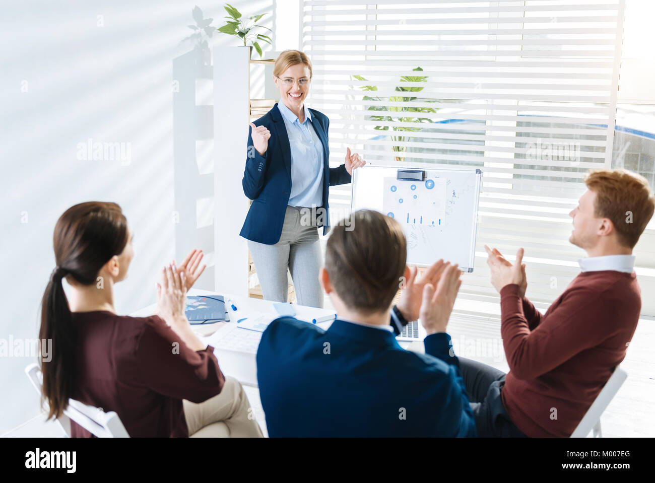 Beautiful female colleague finishing presentation Stock Photo - Alamy
