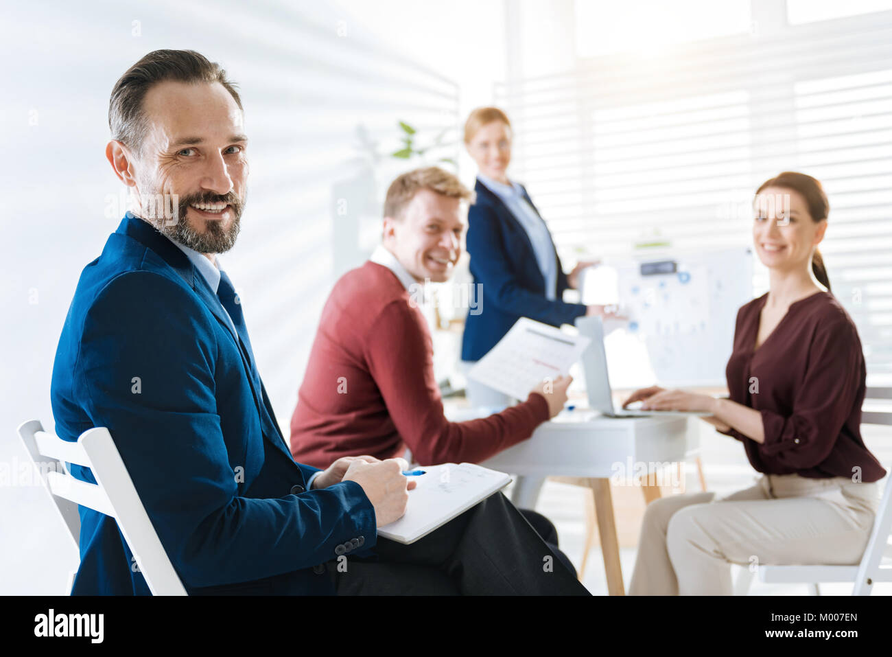 Bearded male colleague noting during meeting Stock Photo - Alamy