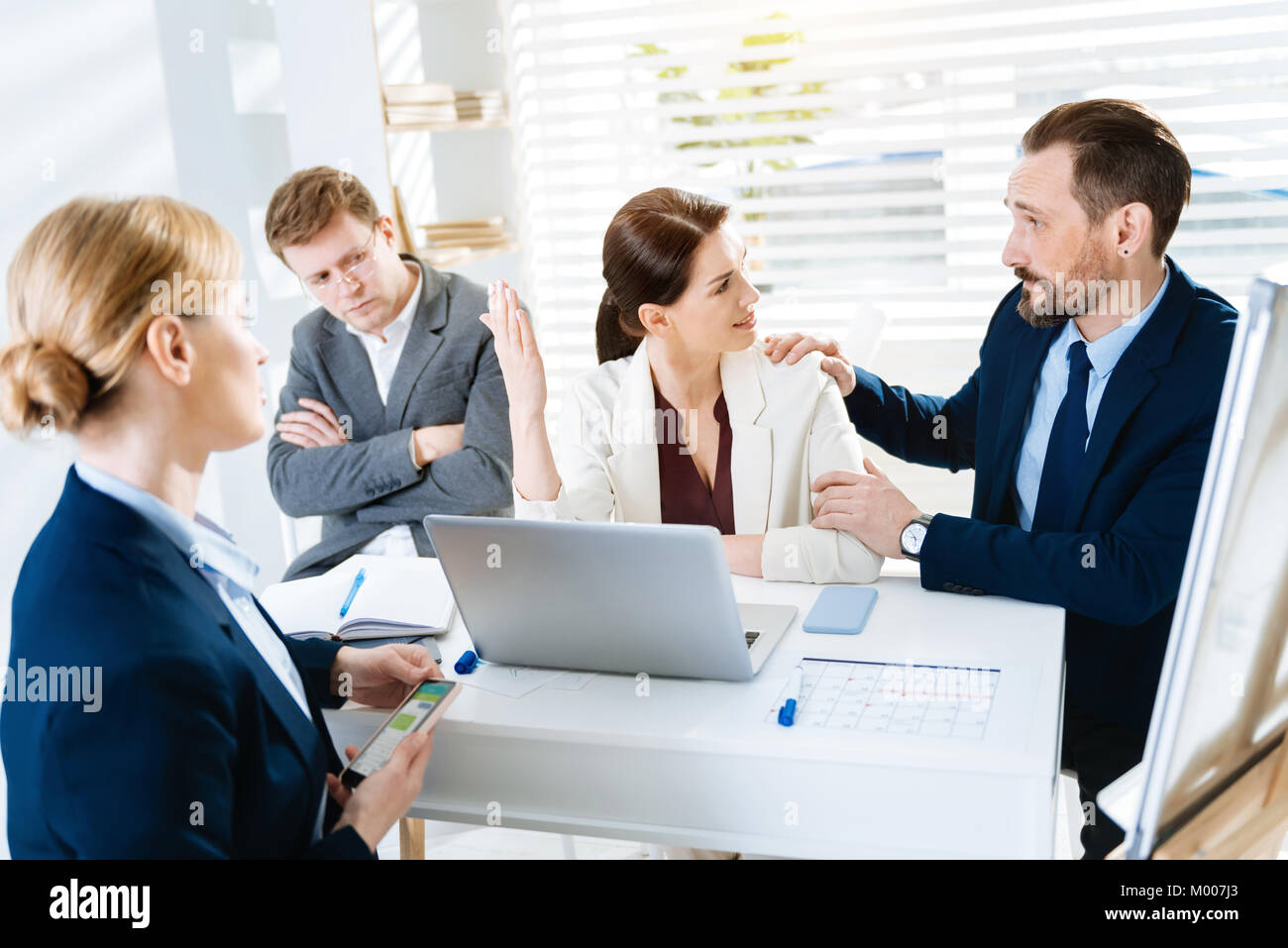 Appealing four colleagues facing troubles Stock Photo - Alamy