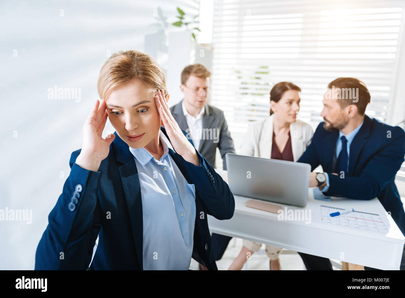 Upset female colleague experiencing stress at work Stock Photo - Alamy