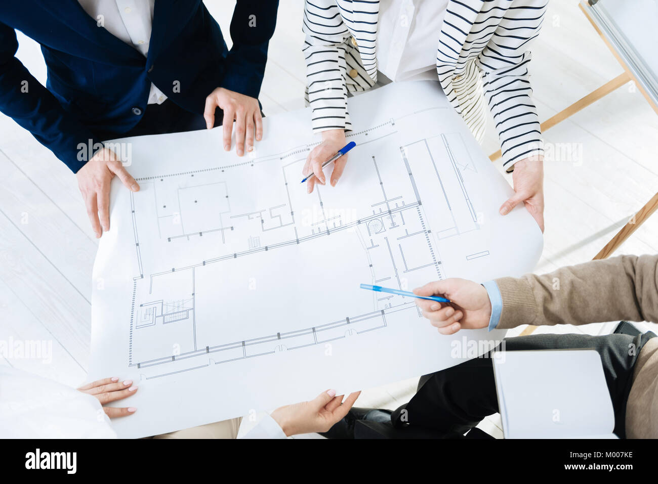 Male and female hands holding blueprint Stock Photo - Alamy