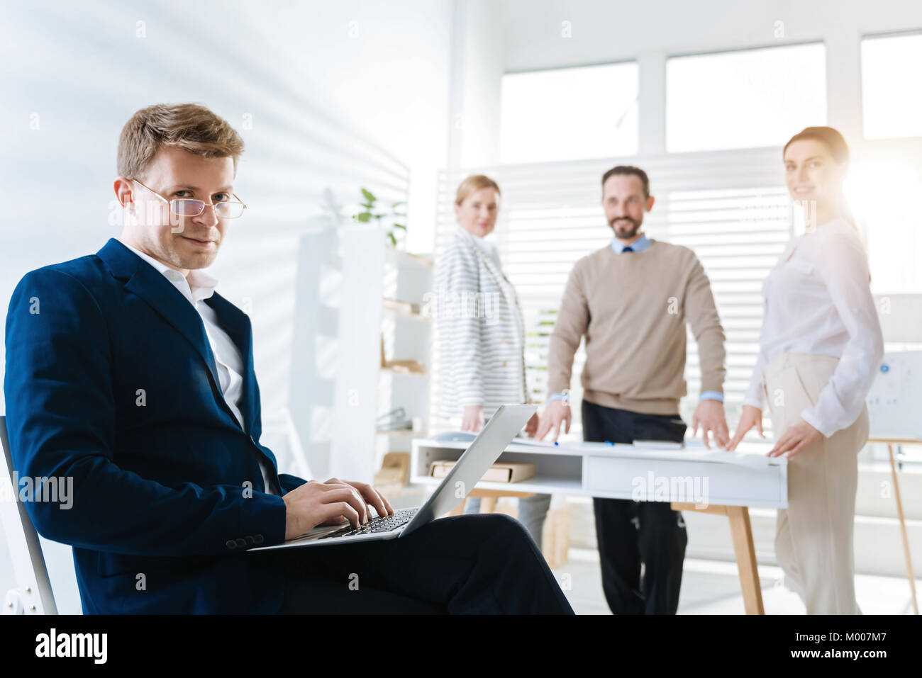 Handsome male colleague typing letter Stock Photo - Alamy