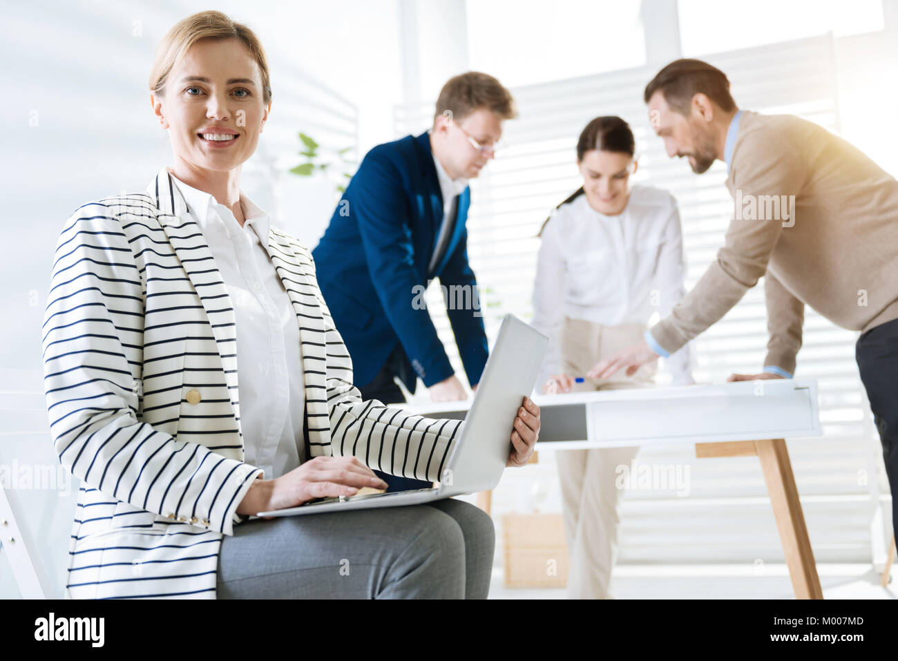 Beautiful female colleague answering online call Stock Photo - Alamy
