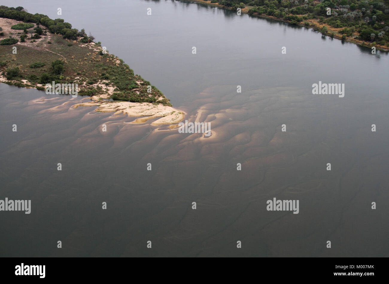 Aerial view of tip of a small island on the Zambezi River separating ...