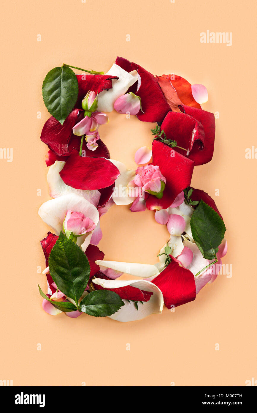 Letter B made from red roses and petals isolated on a white background ...