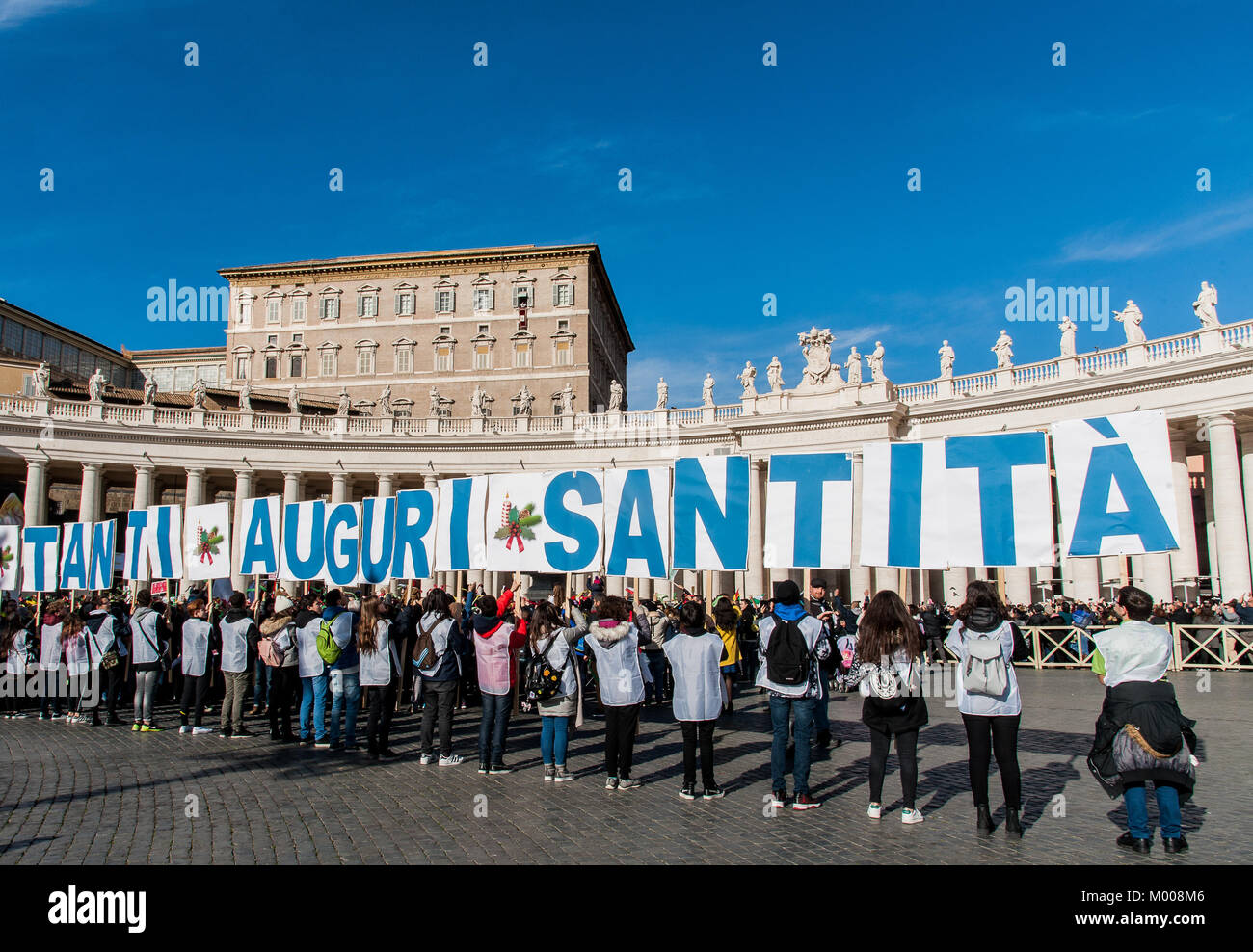 Faithful hold placards reading "Best Wishes Her Holiness" on the ...
