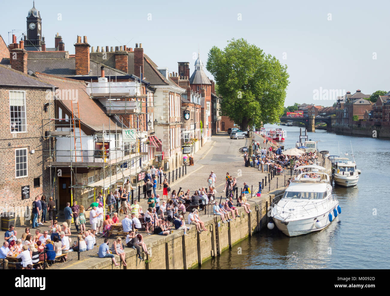 People sitting outside the Kings Arms pub on the River Ouse in York ...