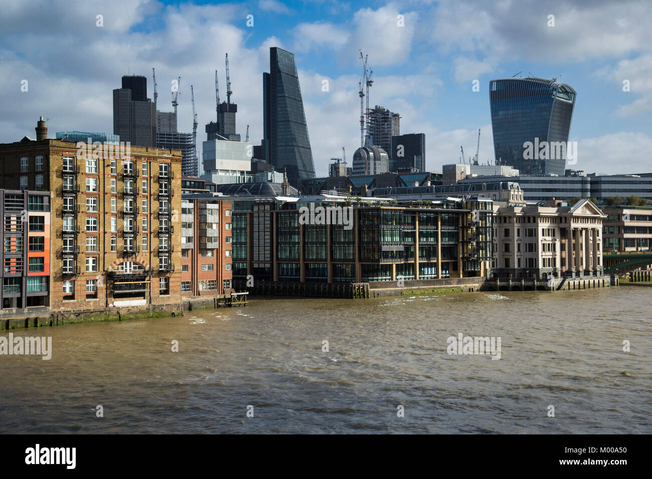 New and modern apartment buildings along bank of the river Thames in ...
