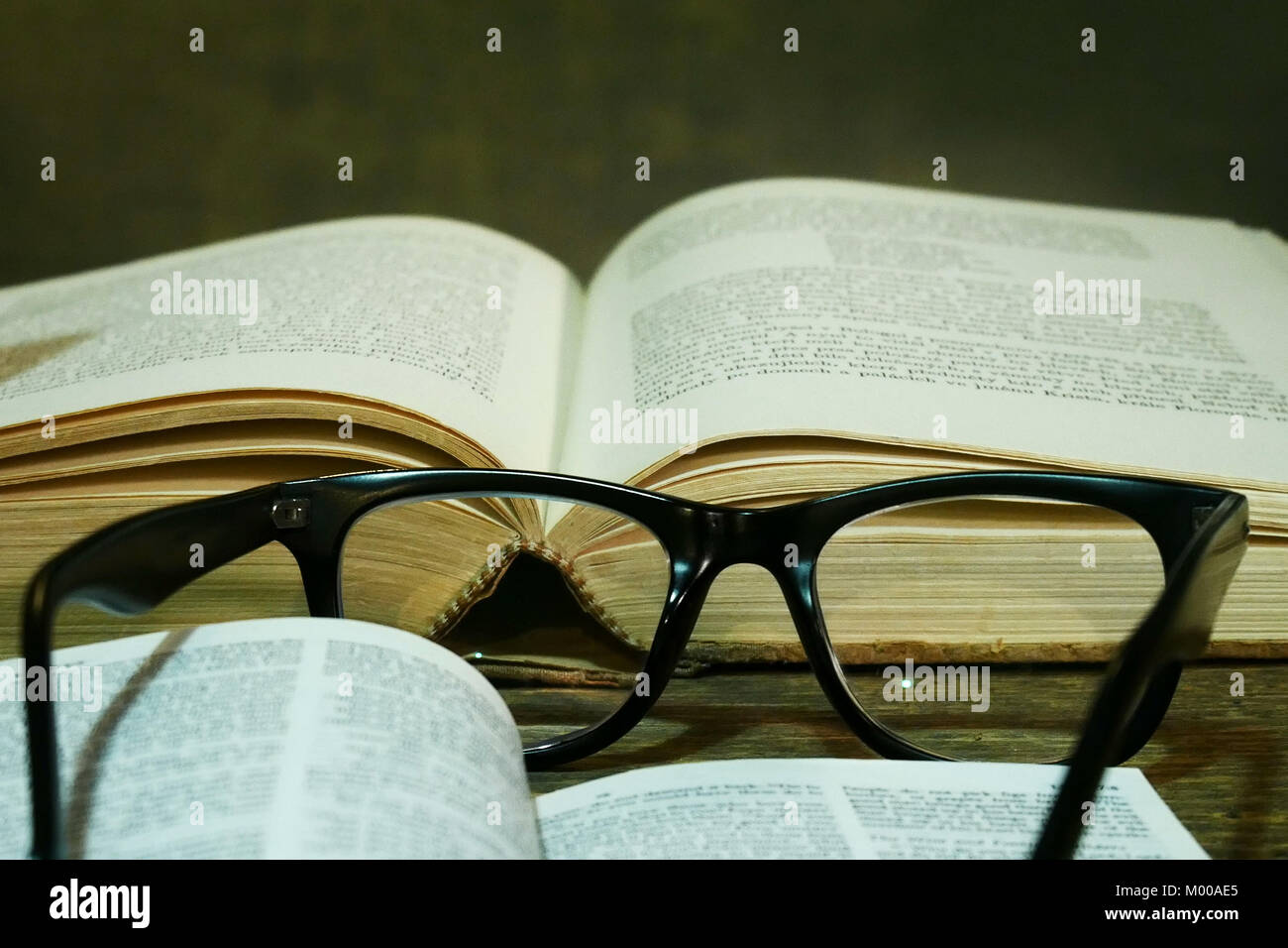 Open Bible with Glasses on the Old Table Stock Photo - Alamy