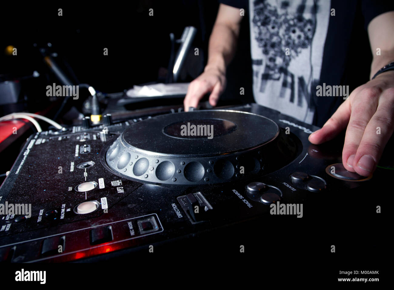 A disc jockey or dj is putting the right tunes and track together at ...