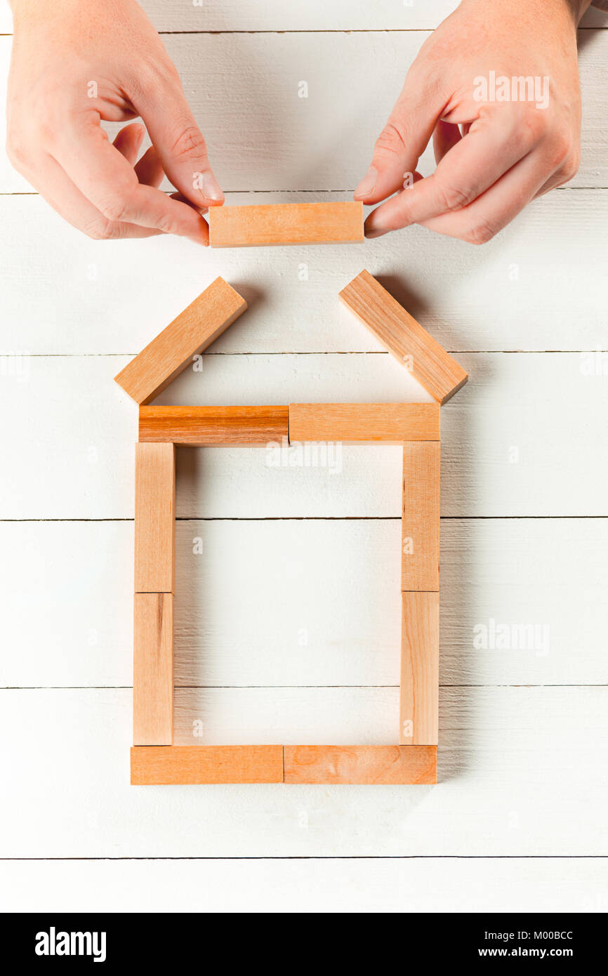 Man and wooden cubes on table. Management concept Stock Photo - Alamy