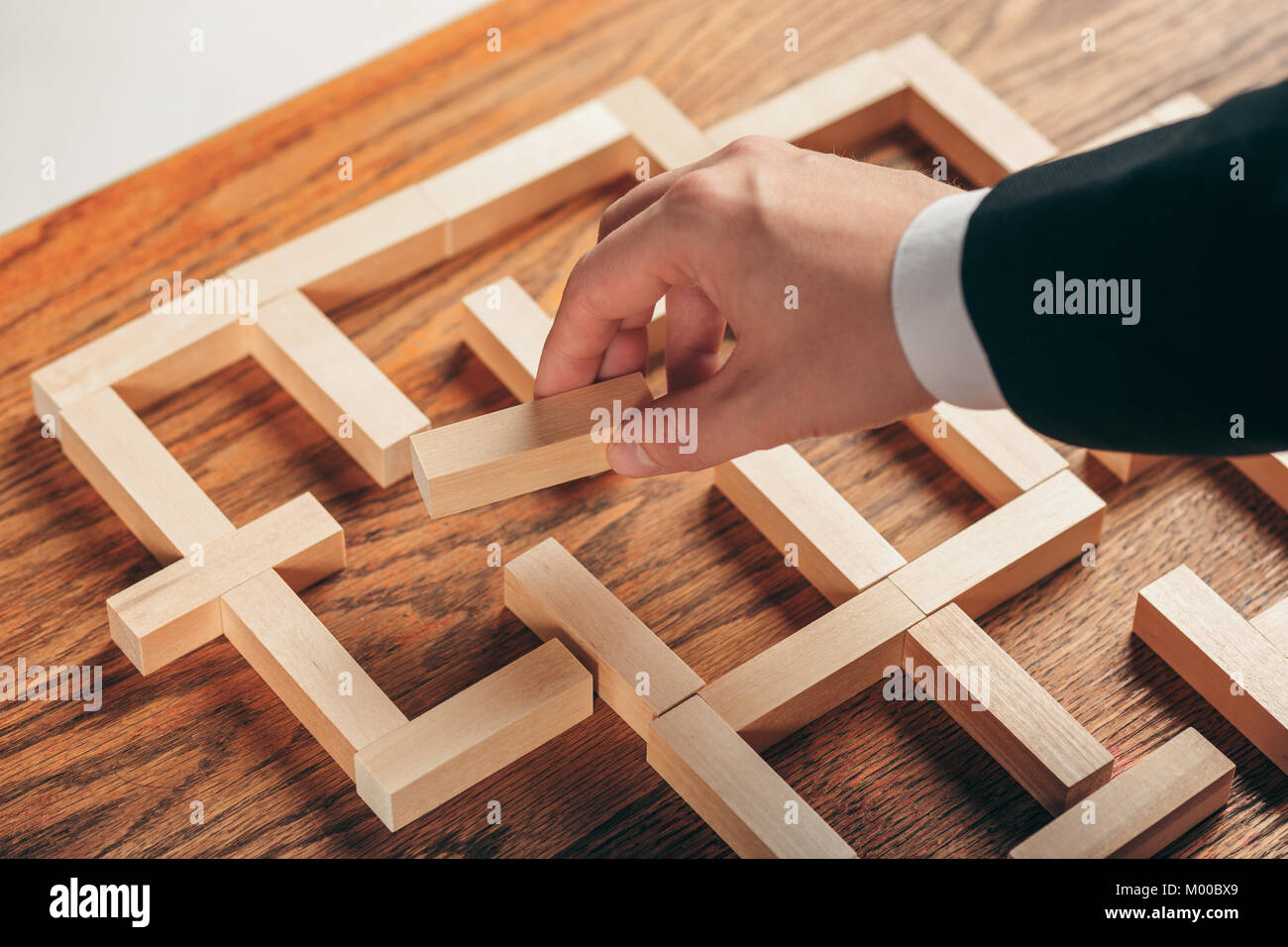 Man and wooden cubes on table. Management concept Stock Photo - Alamy