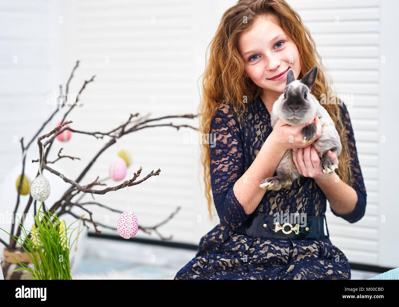 Red-haired girl portrait with cute rabbit on white background around ...