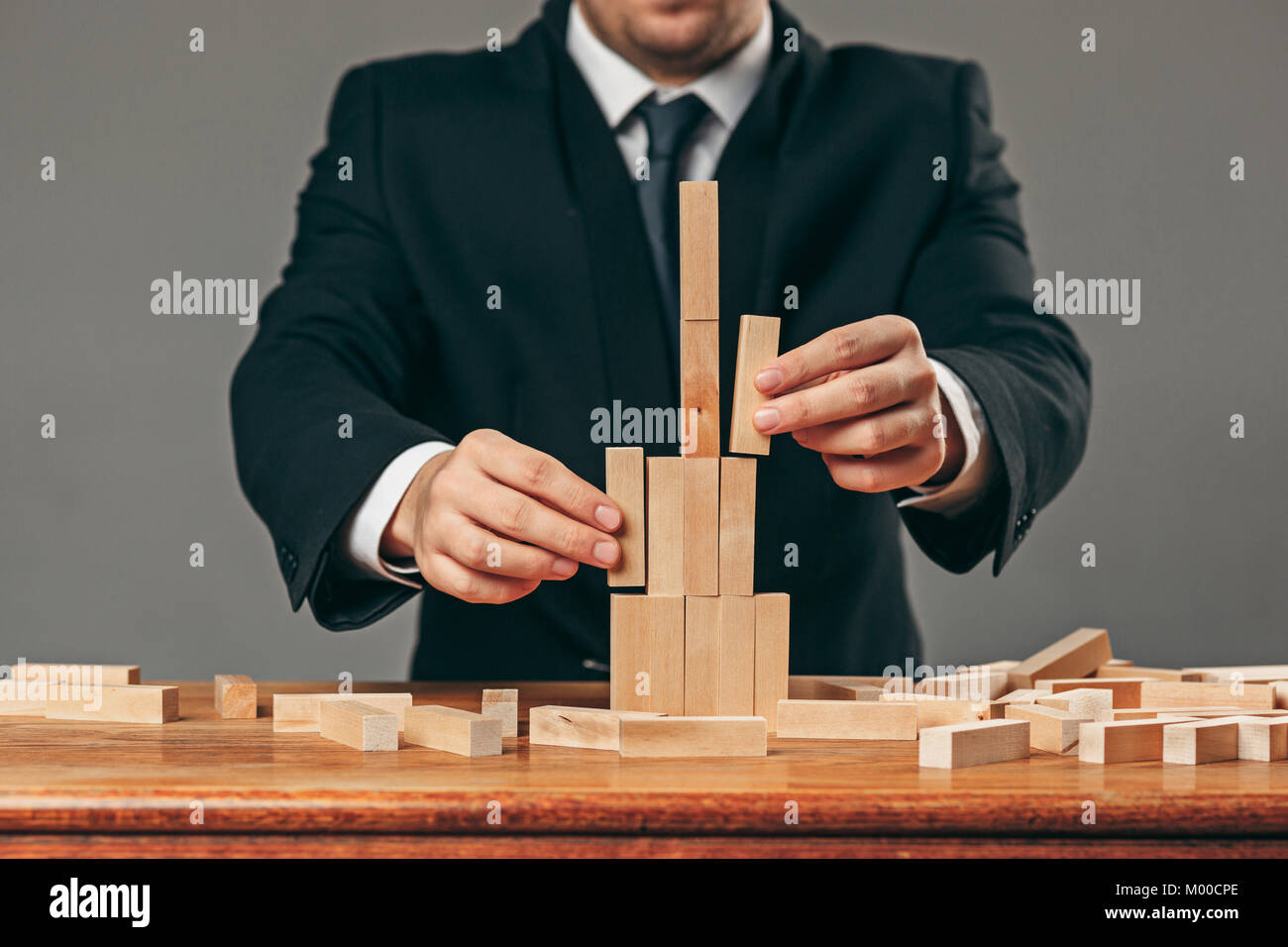 Man and wooden cubes on table. Management concept Stock Photo - Alamy