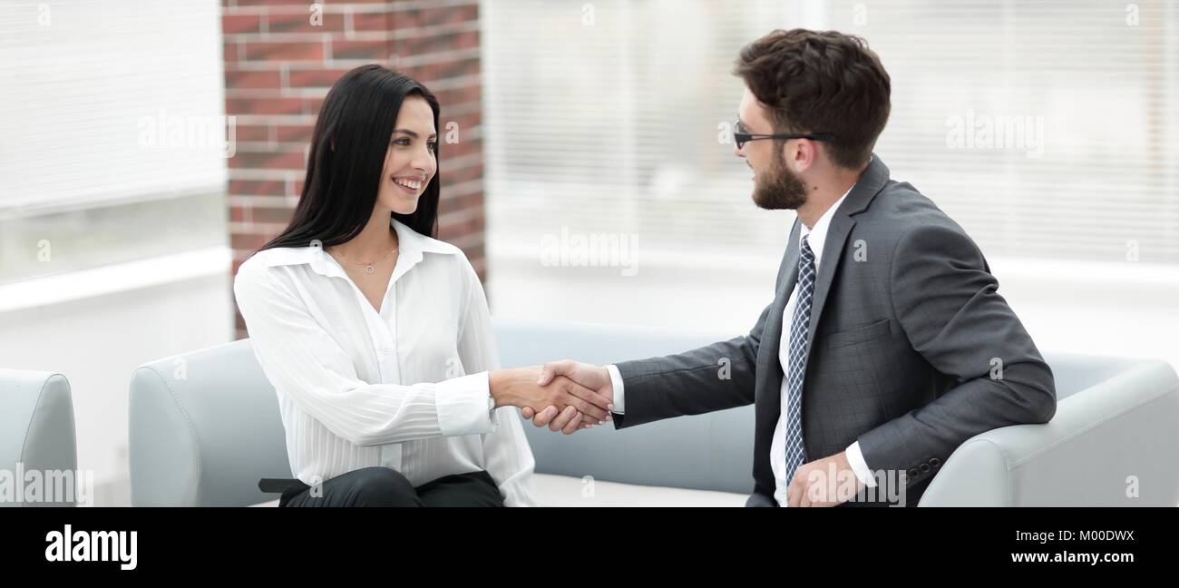 handshake of manager and client sitting in the office lobby Stock Photo ...