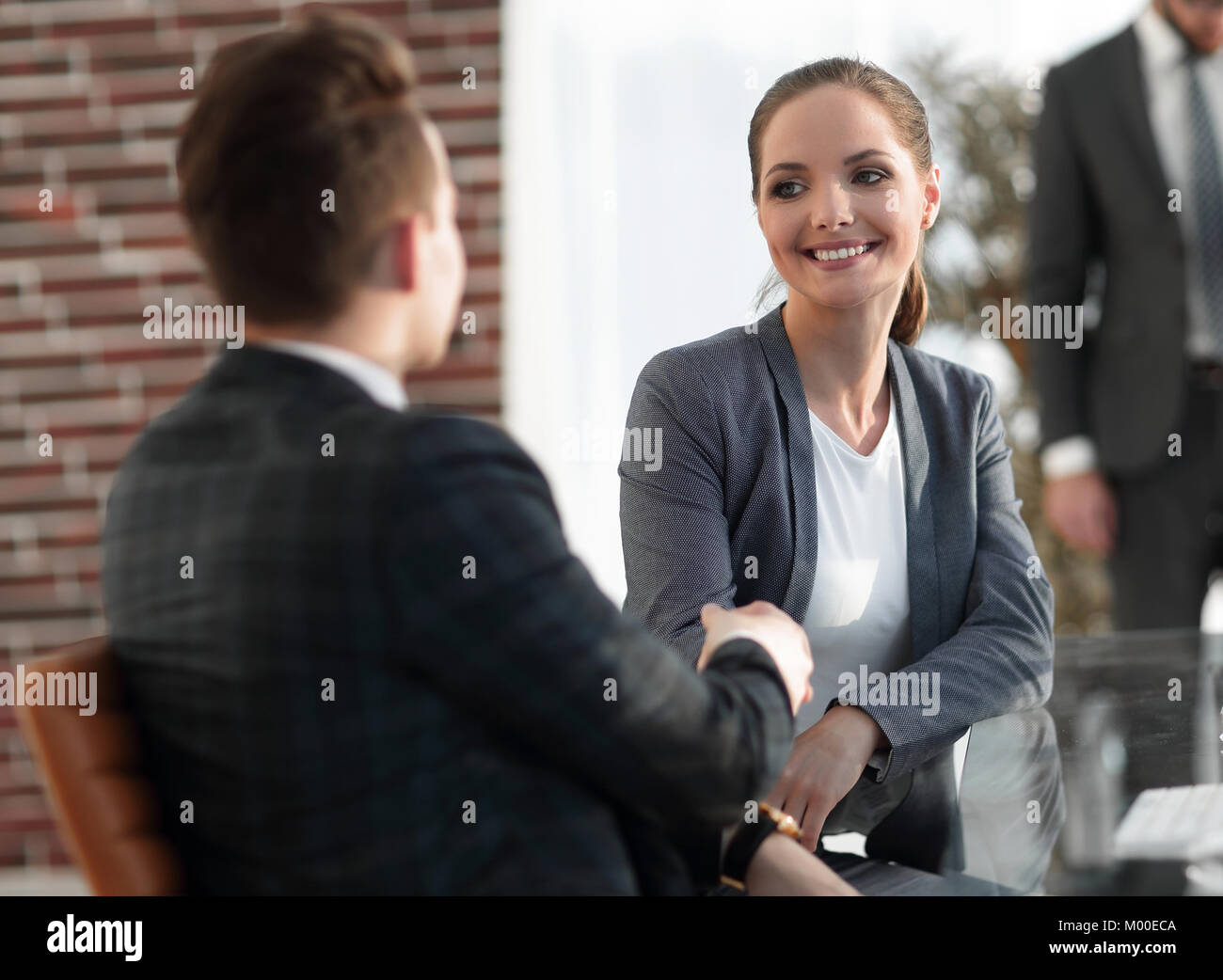 handshake Manager and the client in the office Stock Photo - Alamy