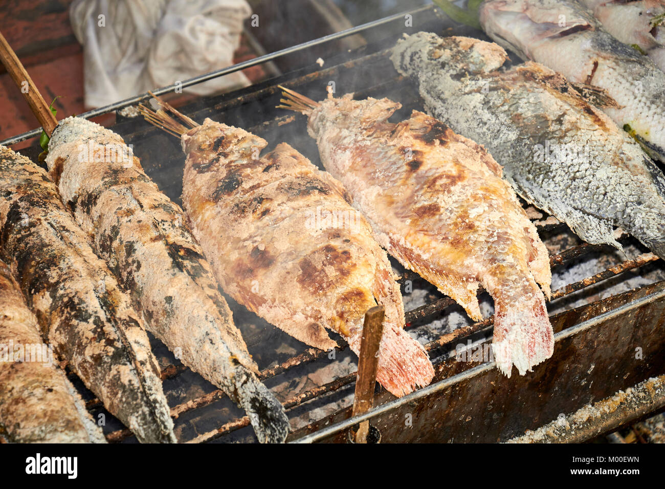 Whole fish grilling at the Taling Chan floating market in Bangkok ...