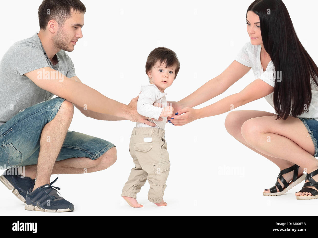 parents watching the baby take the first steps Stock Photo - Alamy