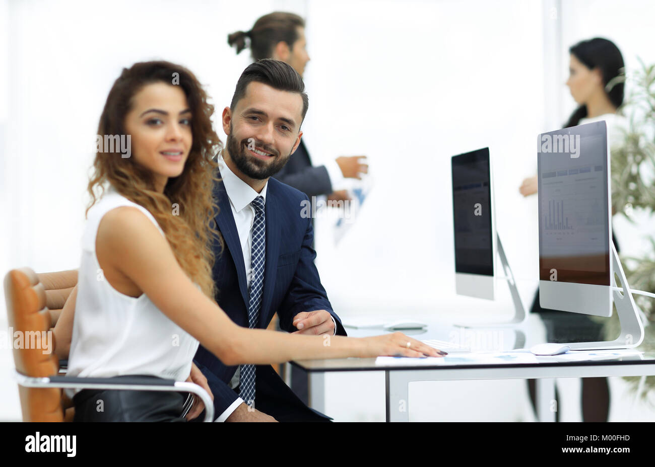 couple of colleagues sitting at a Desk Stock Photo - Alamy