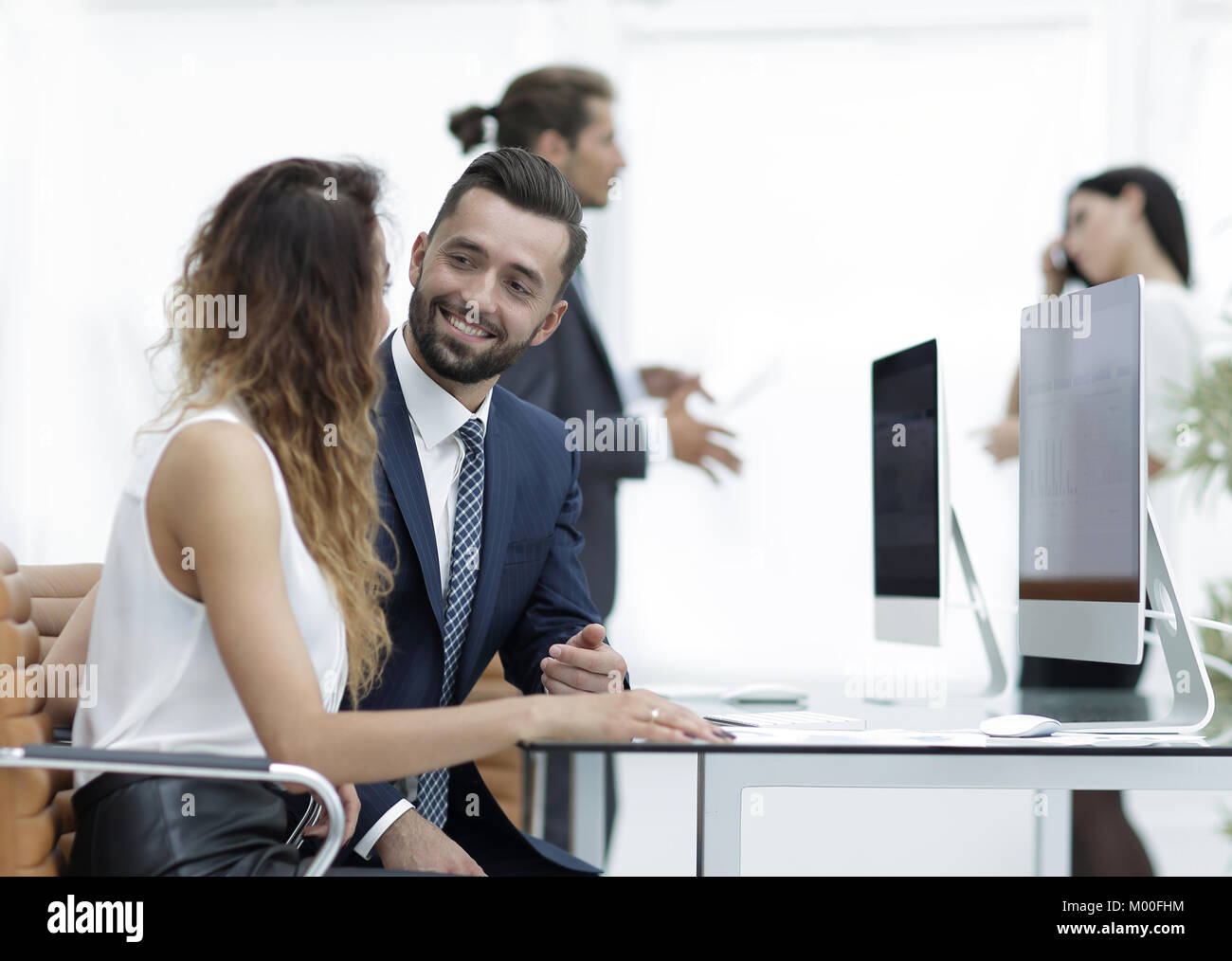 colleagues talking, sitting at your Desk Stock Photo - Alamy